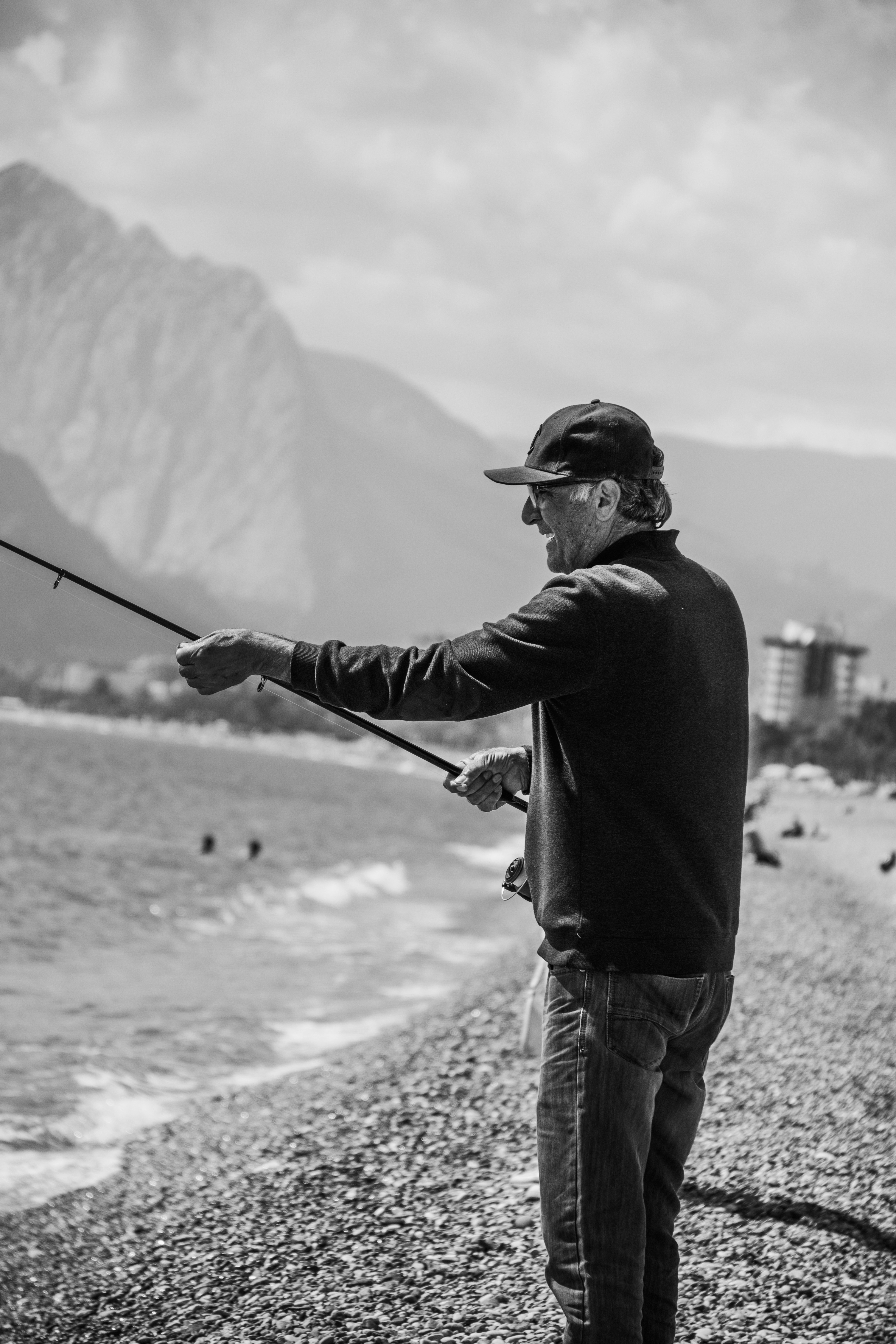 Line and Lure: A Quiet Beach Portrait of a Angler in Motion