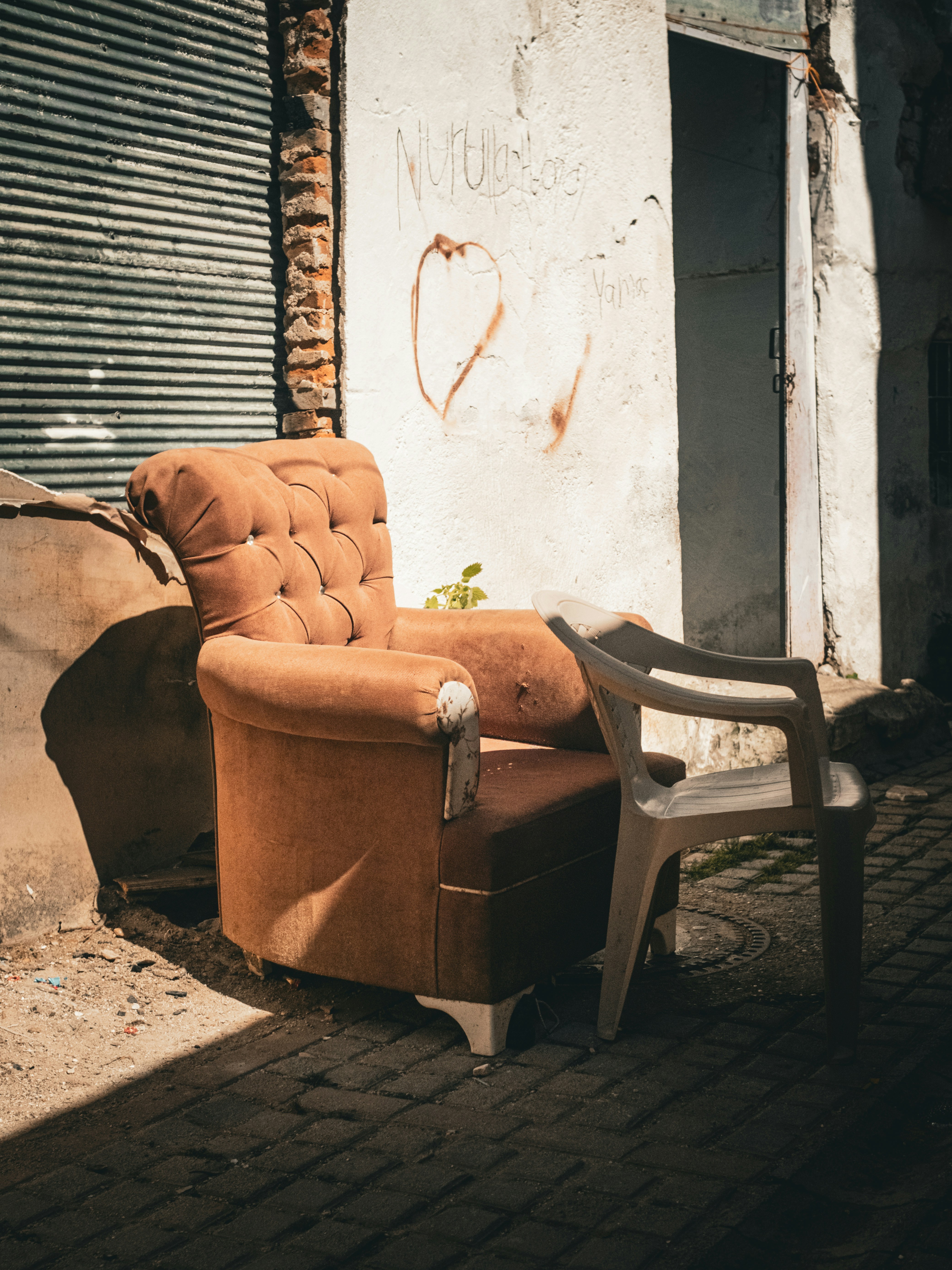 Abandoned Comfort: Sunlit Armchair in a Quiet Calle