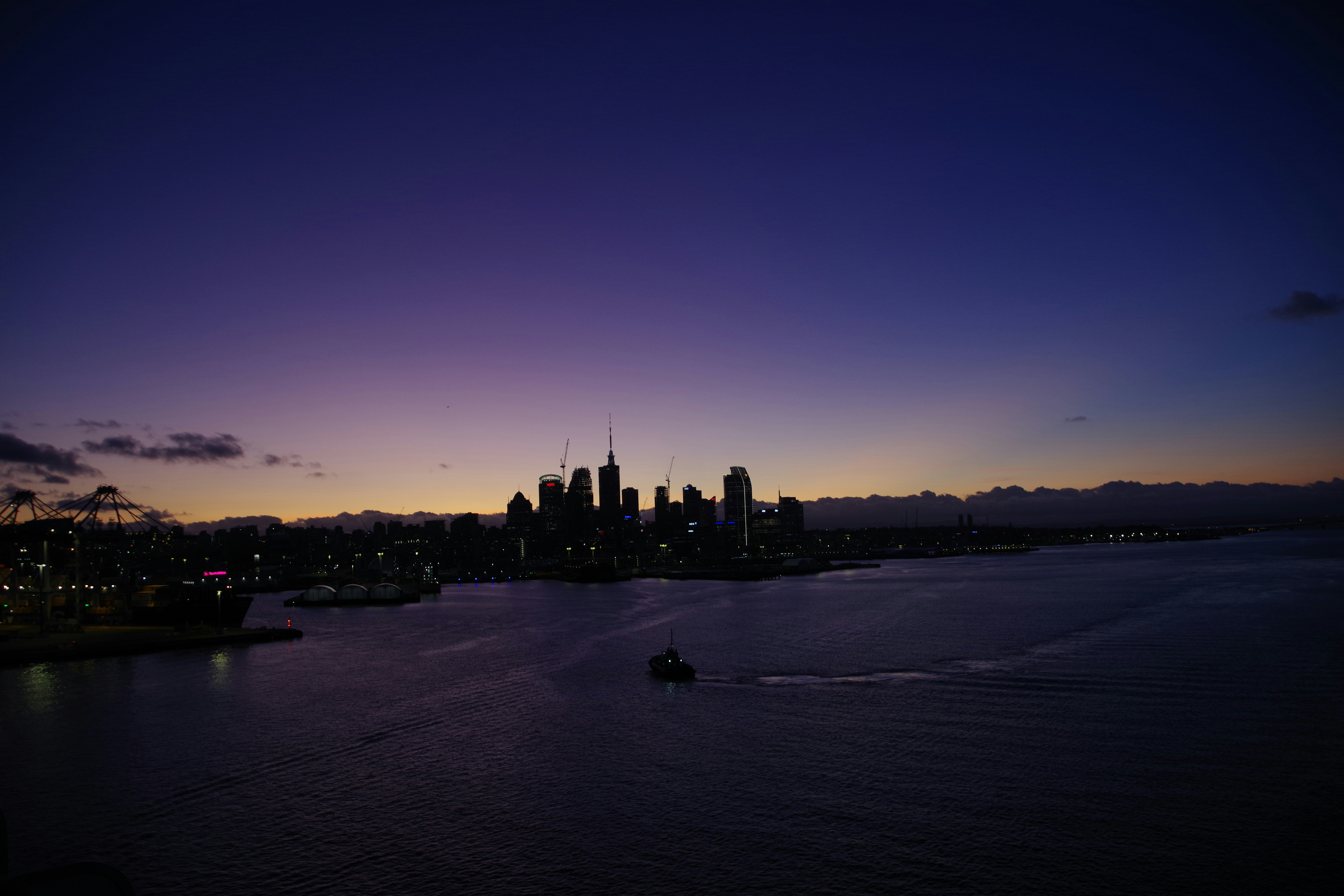 Dusk Over the Harbor: City Silhouette Beneath a Gradient Sky