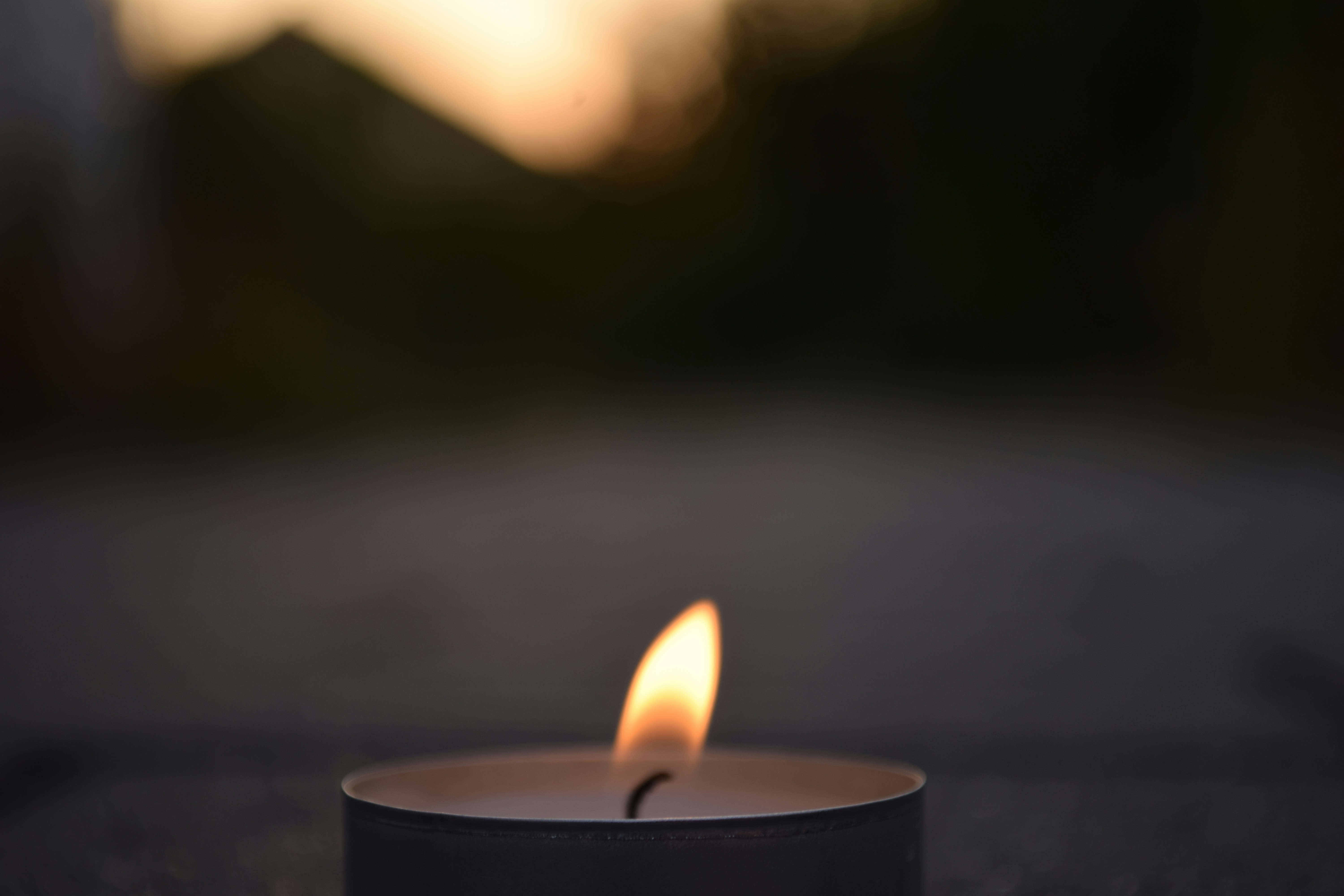 Centered Flame: A Single Candle Glow on a Quiet Surface