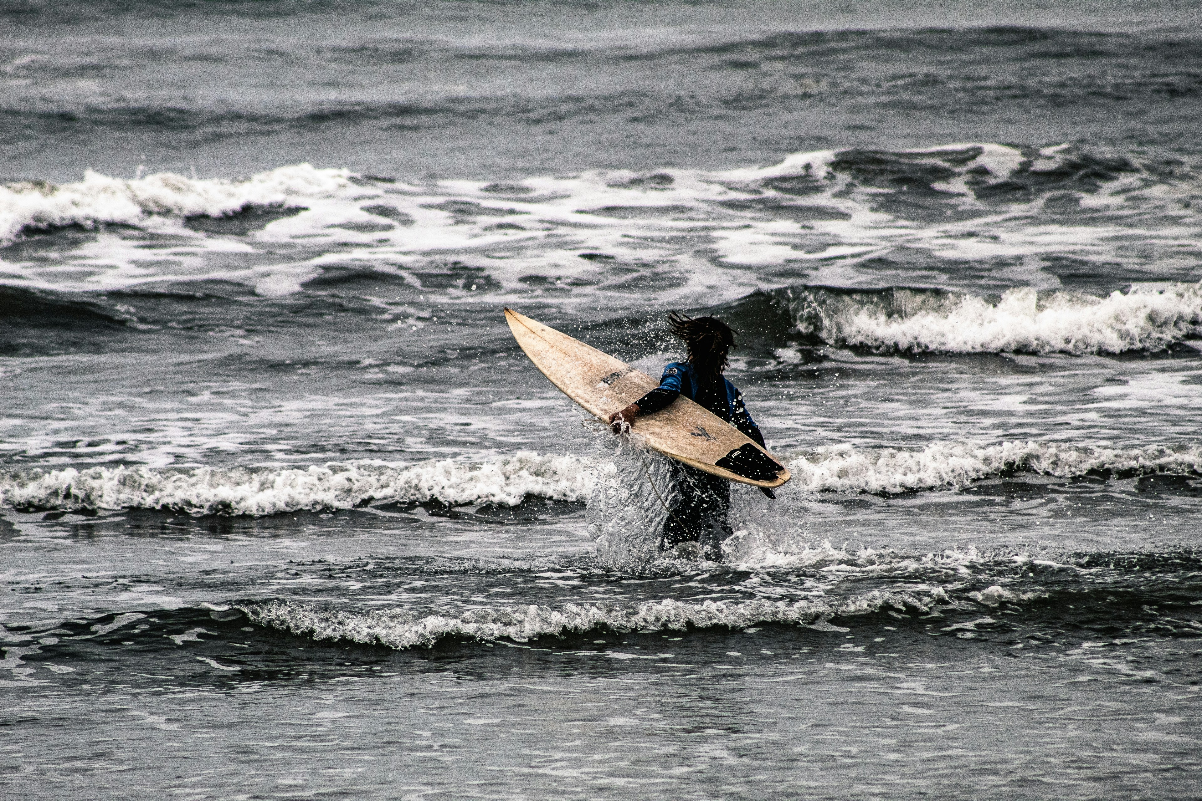 Surfer in Cresting Break with Wooden Board