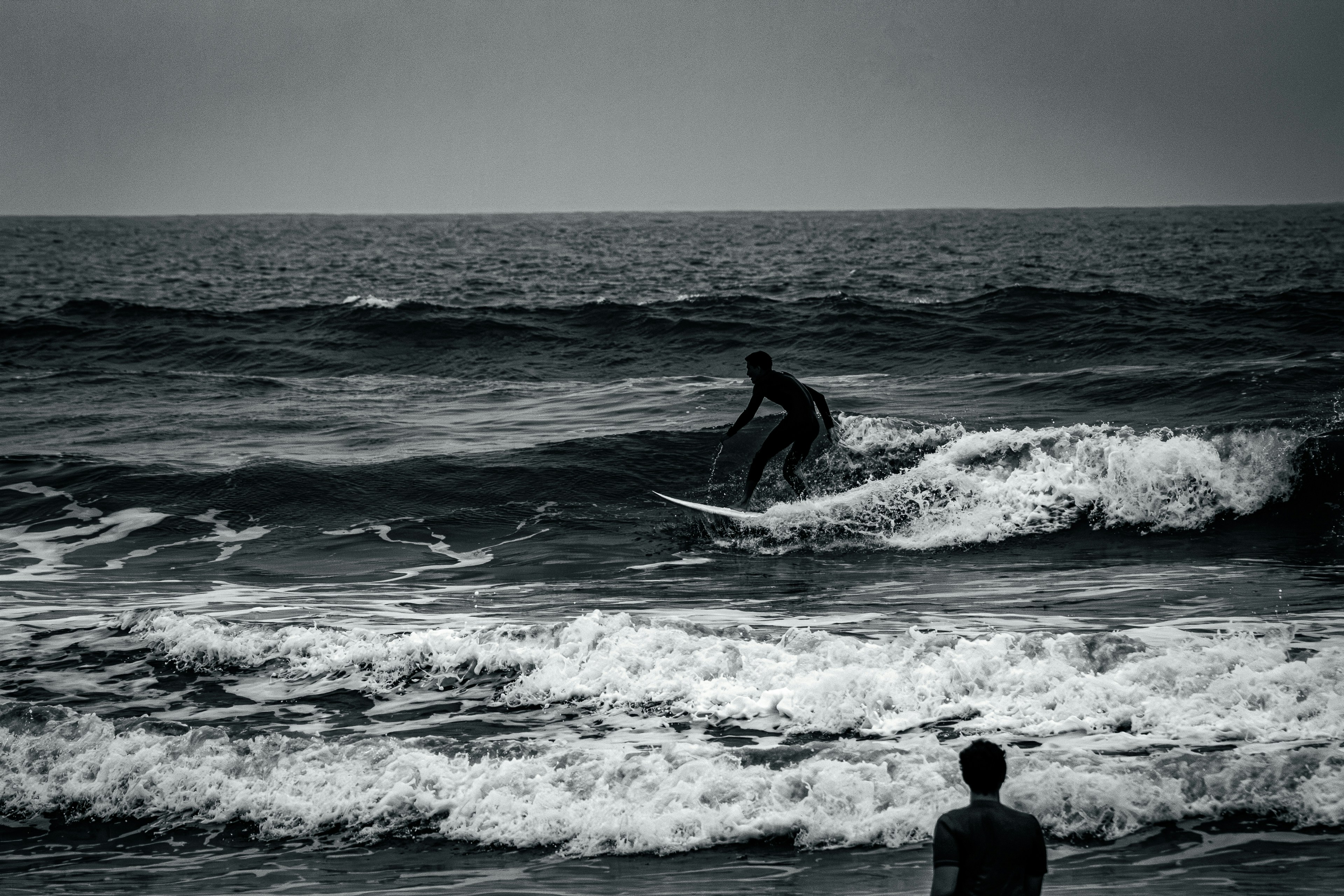 Mid-Sea Silhouette: A Surfer in Quiet Undertow