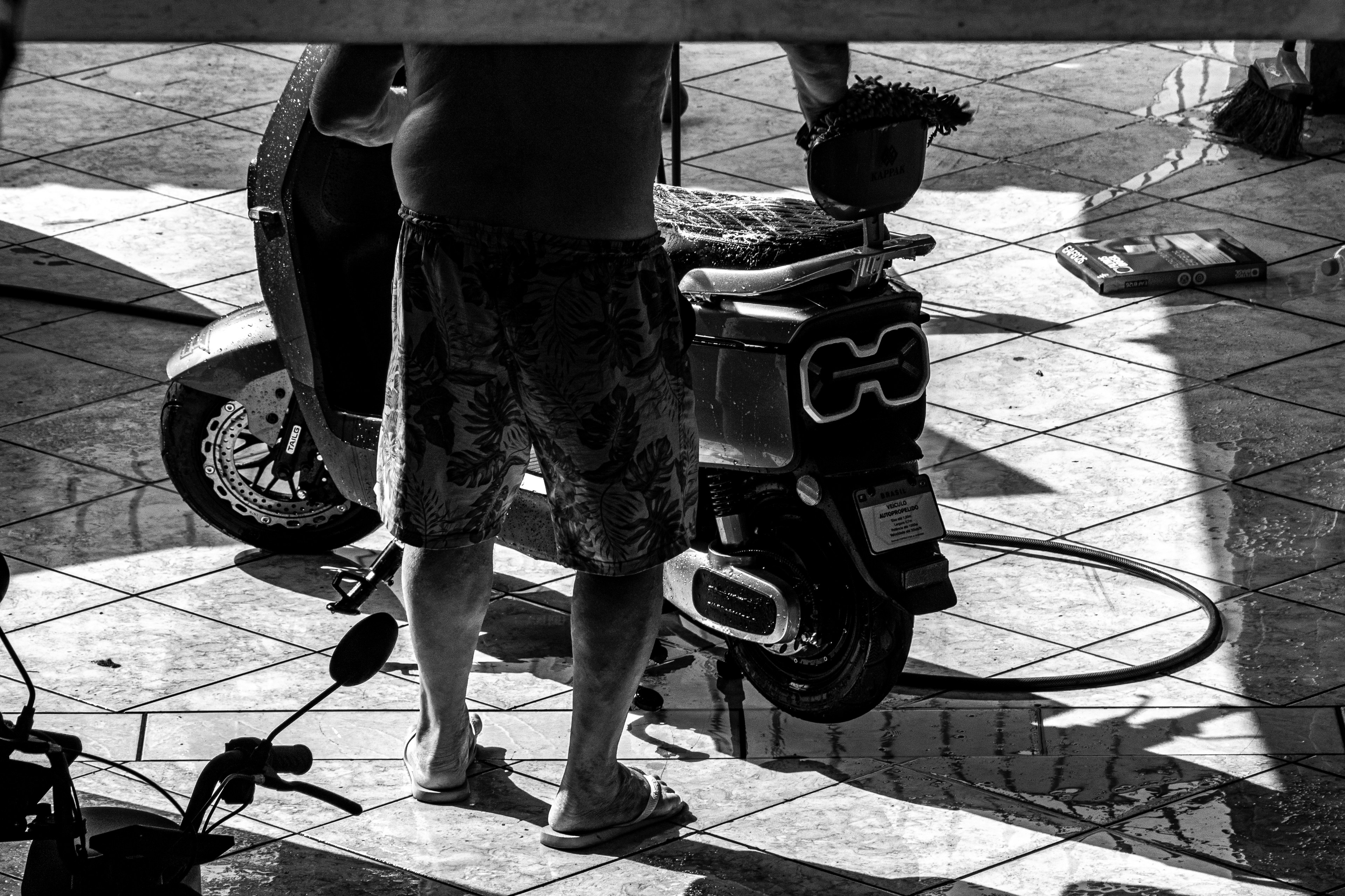 Grounded Stance: A Street Scene with a Scooter and Shadowed Steps