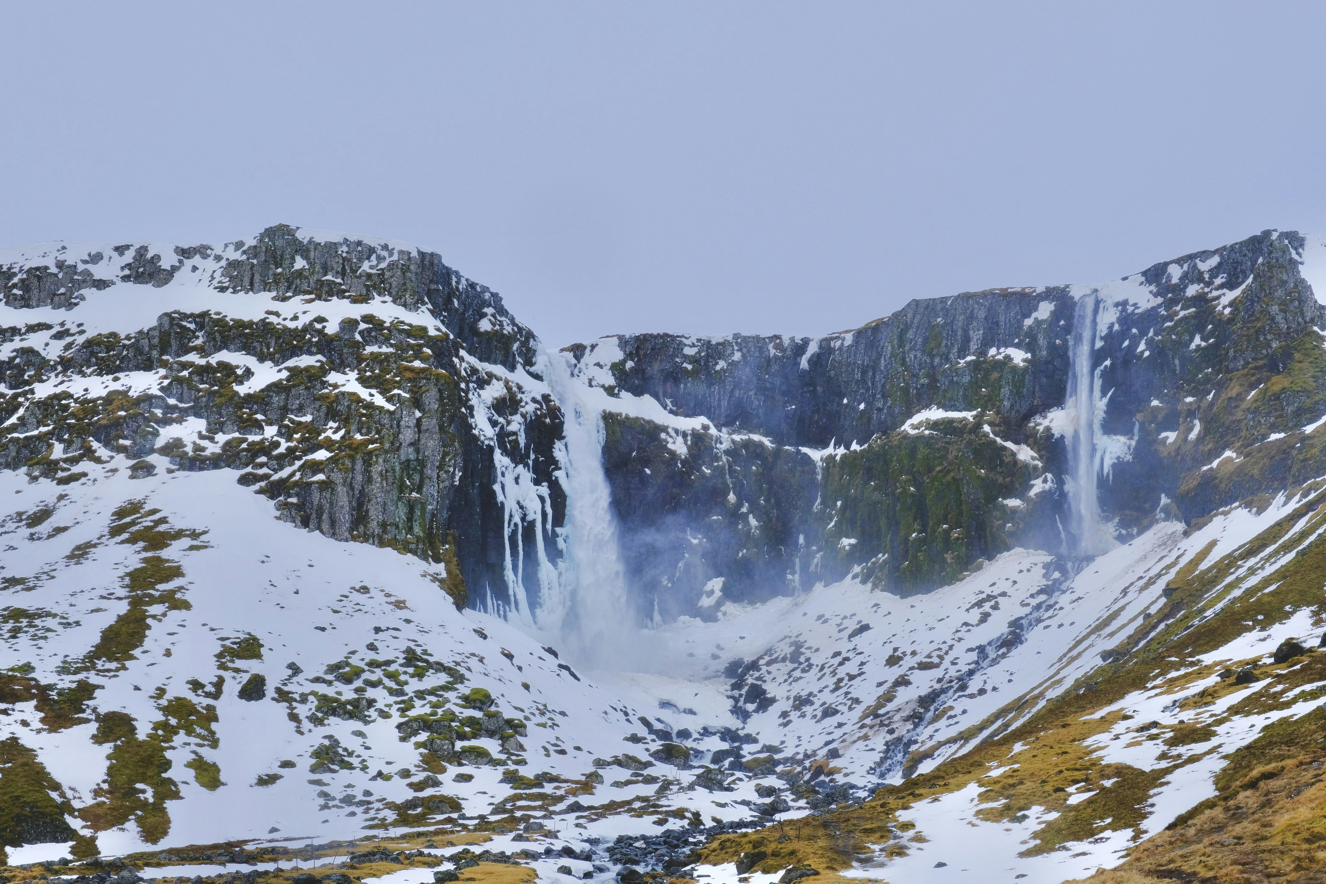 Icy Cascade Amid Snowy Wallscape