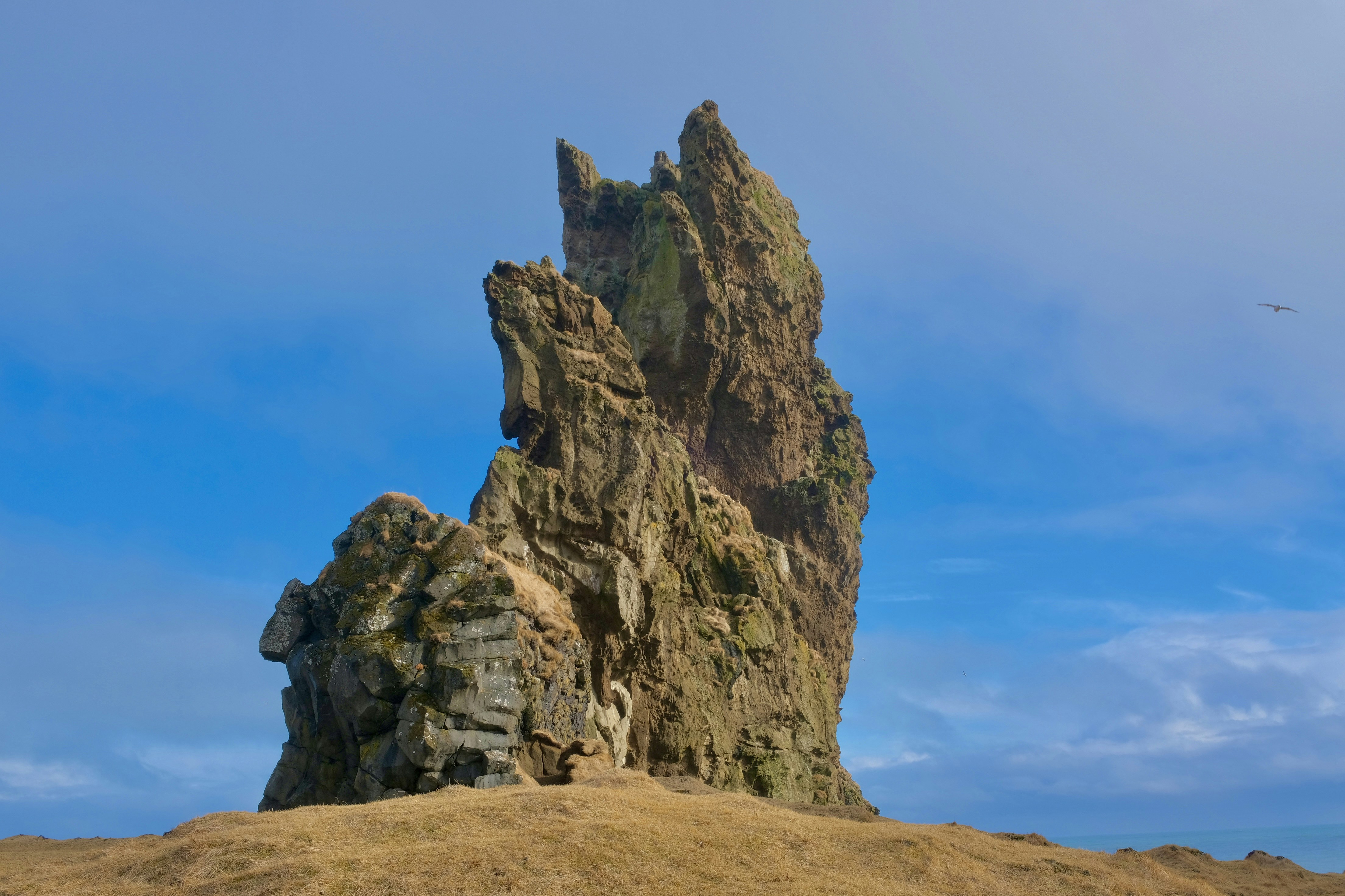 Stony Sentinel: A Lone Rock Rising from Golden Hills