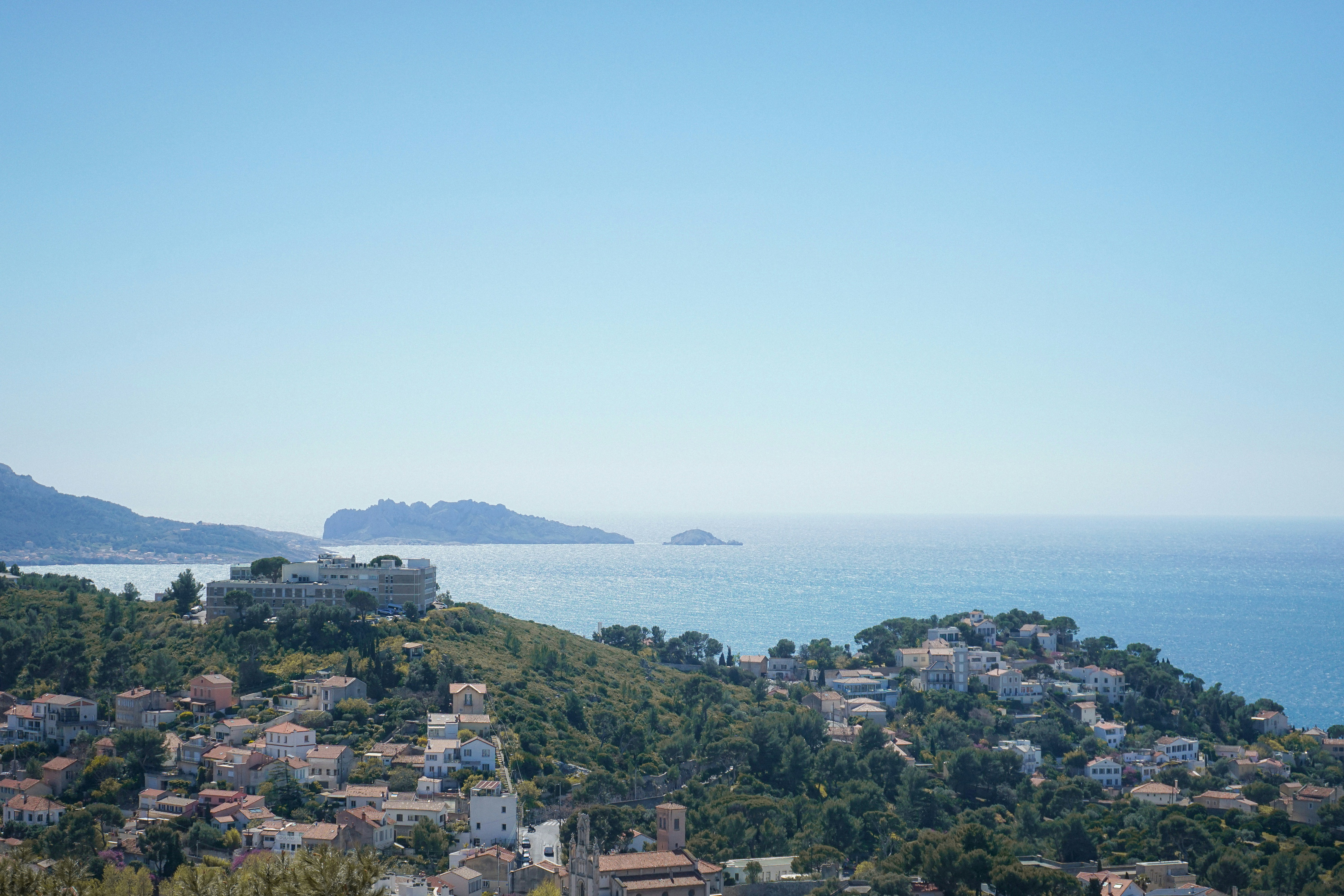Coastal Crest: A Mediterranean Town Basking in Midday Light