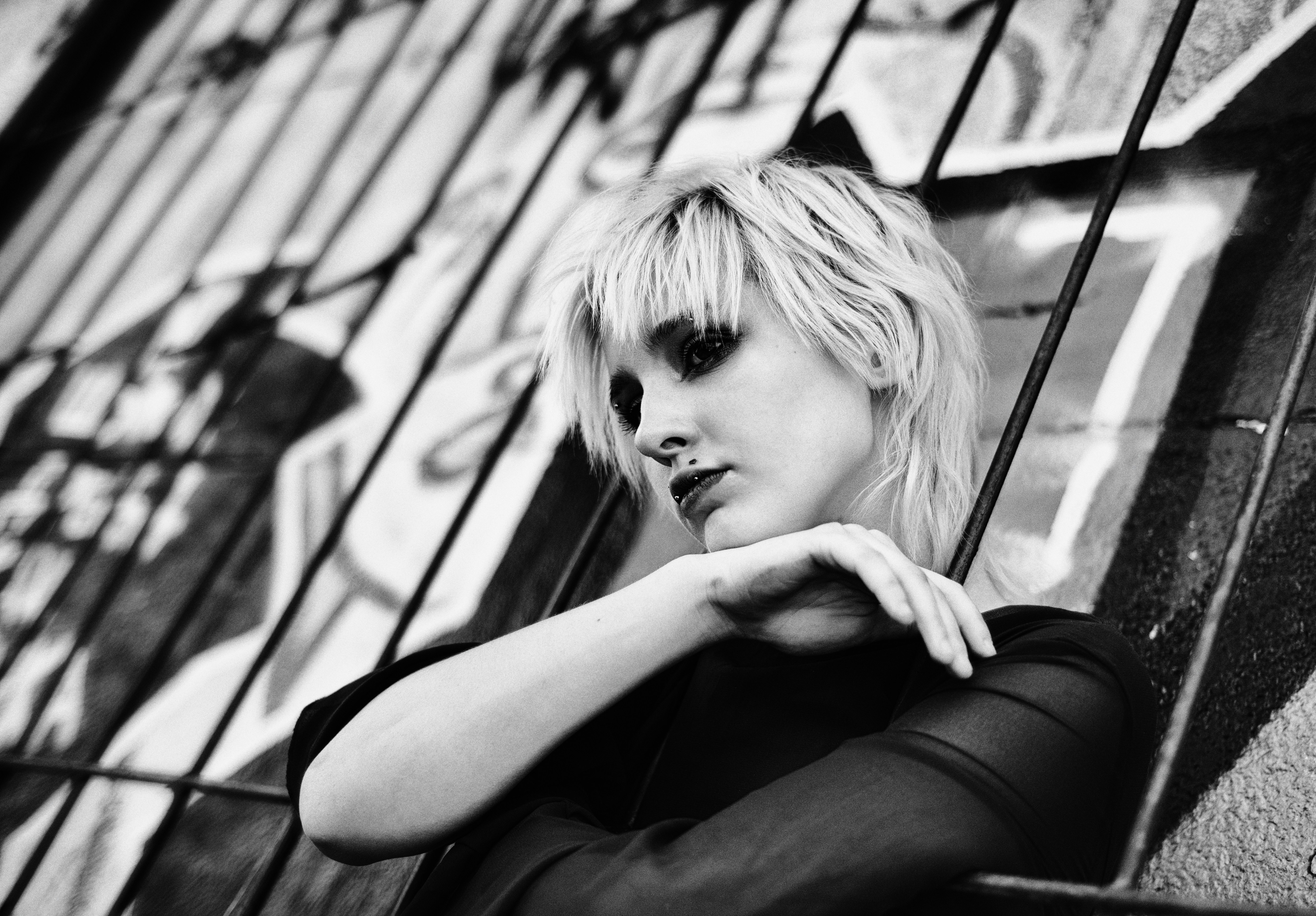 Urban Portrait in Mono: Framed by Graffiti and Shadows