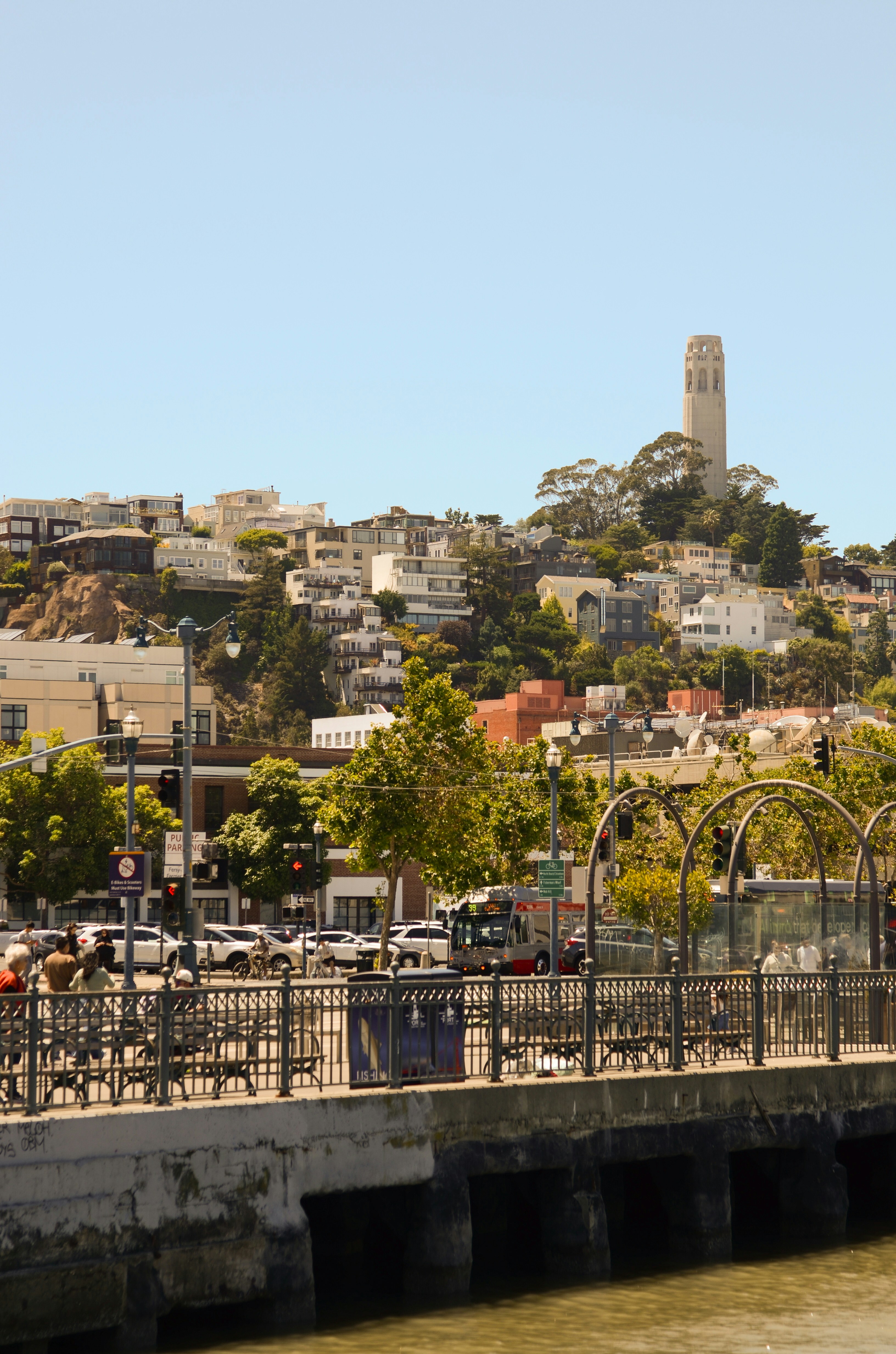 Coit tower overlooks the san francisco cityscape and waterfront promenade.