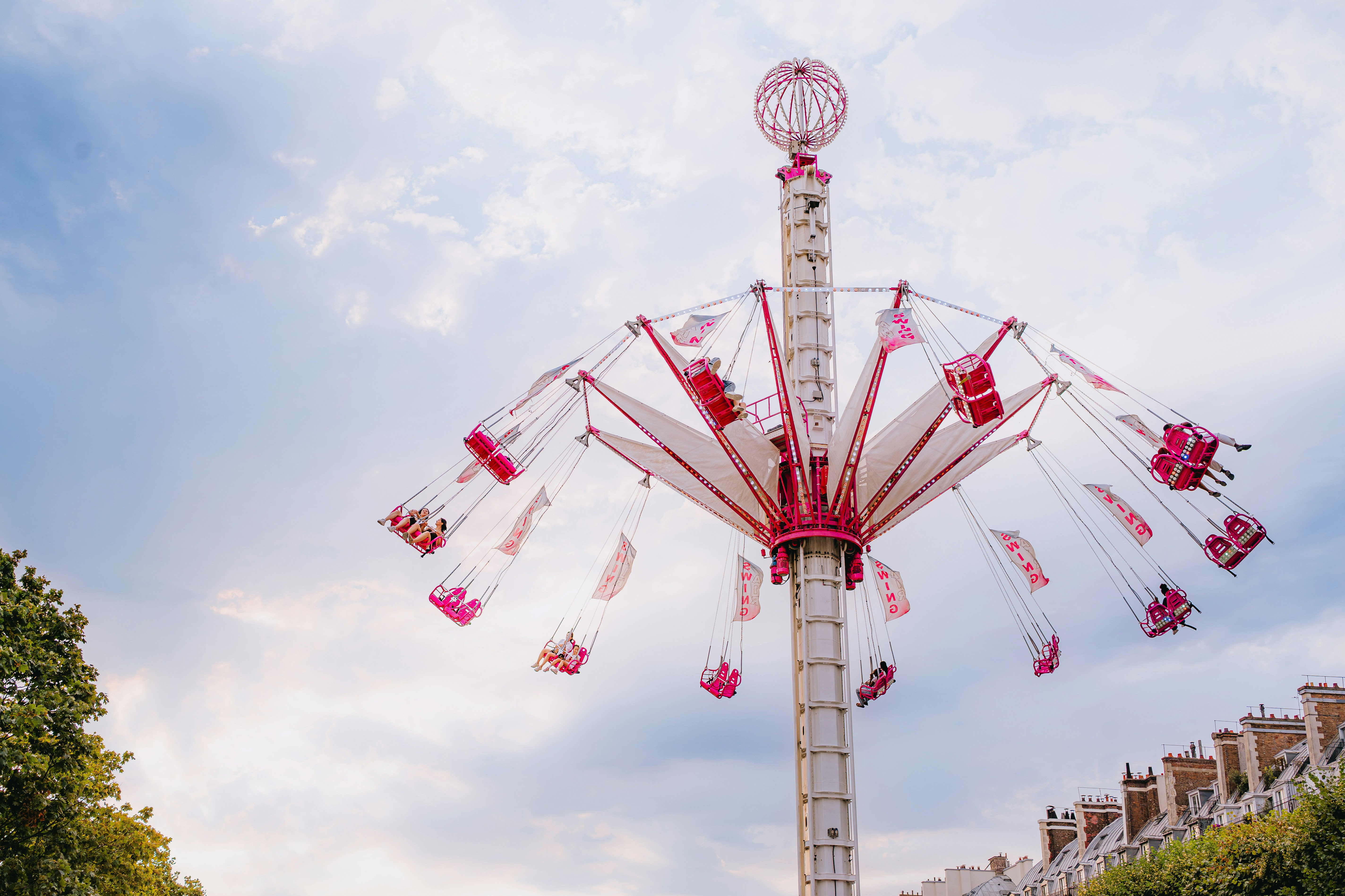 Swinging Skyline: A carnival carousel against a bright afternoon sky