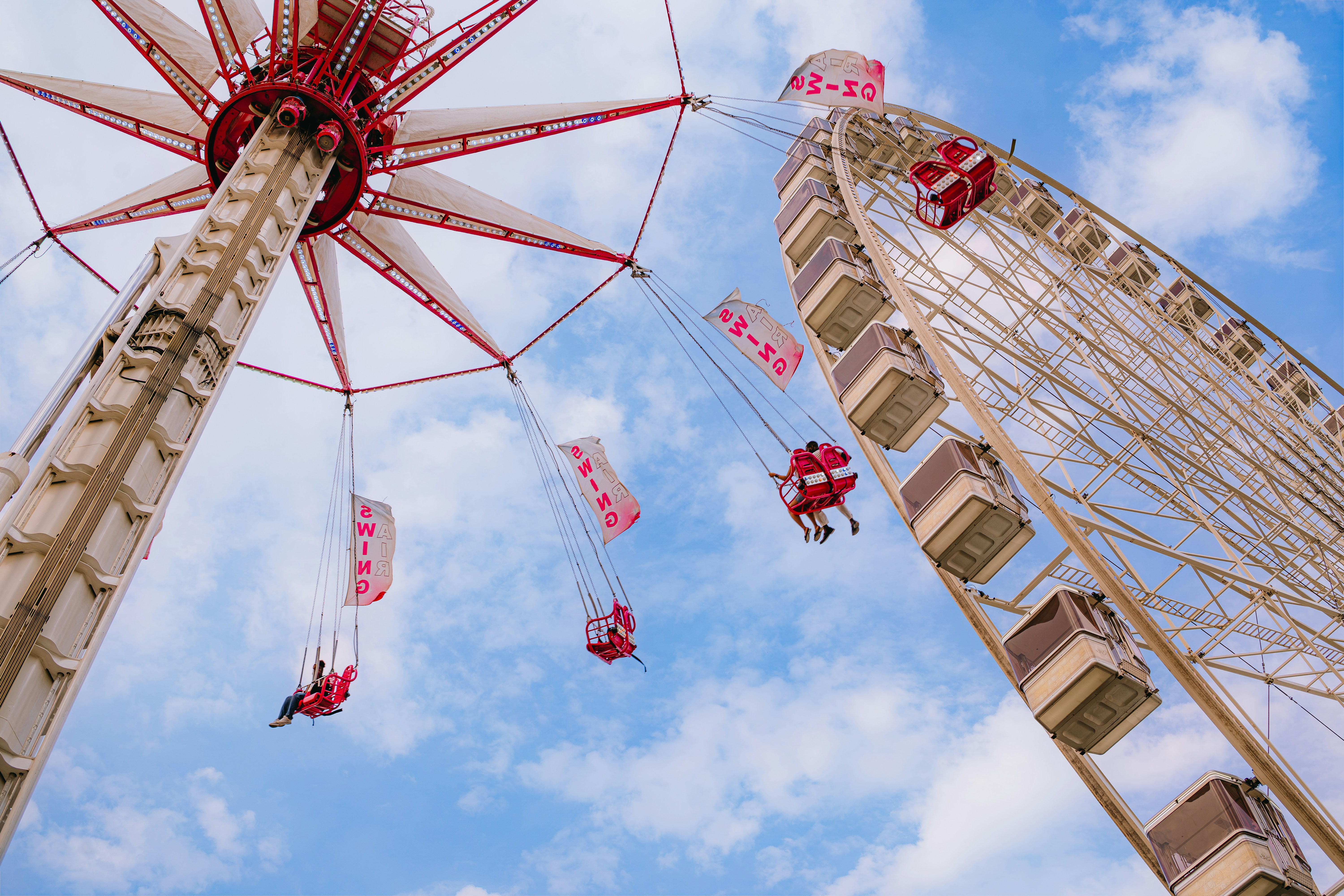 Swinging Skyward: A Aerial View of the Carnival Ferris Wheel and Swing Ride