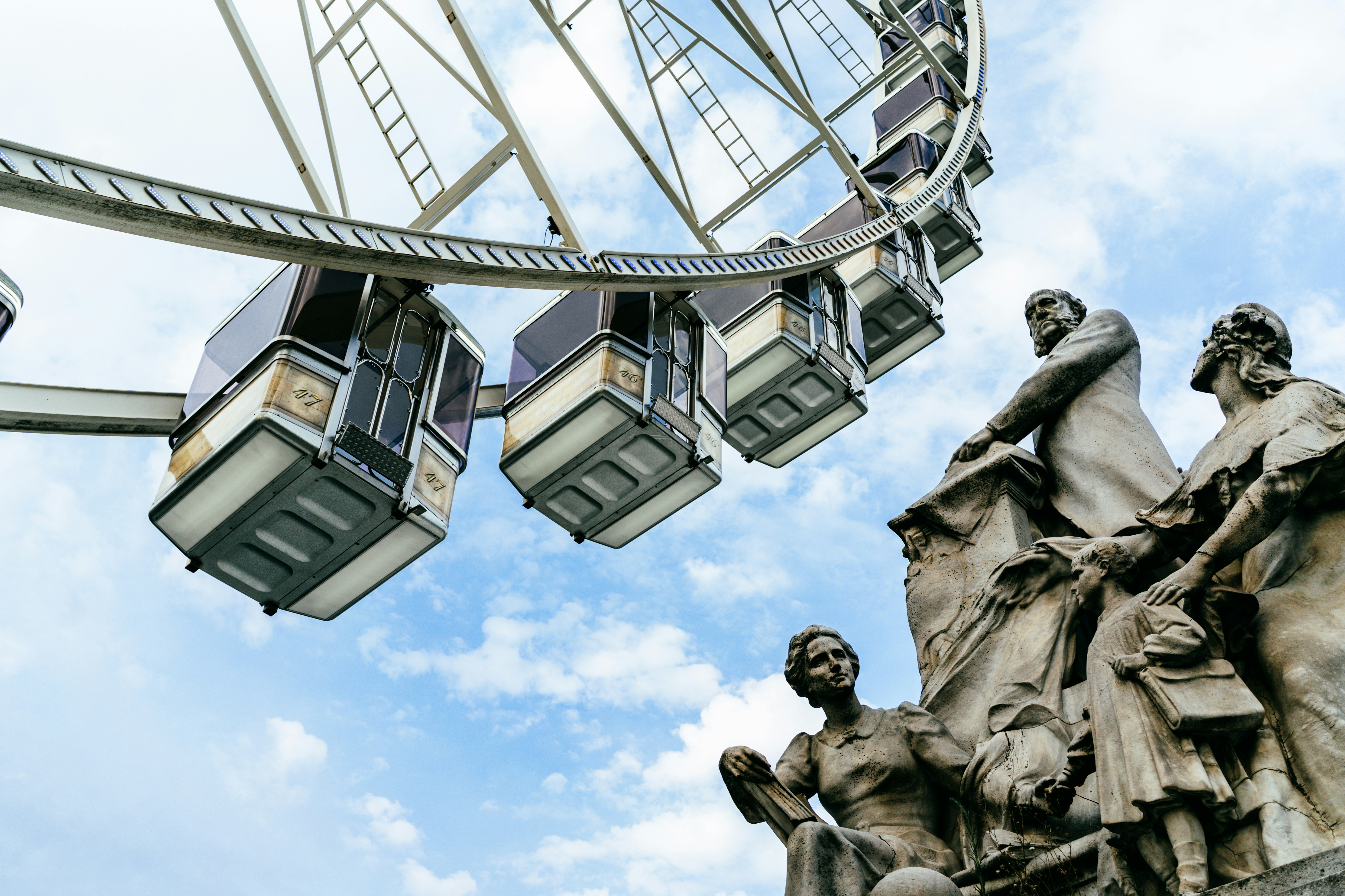 Ferris Wheel Over the Statues: Skyward Contrast