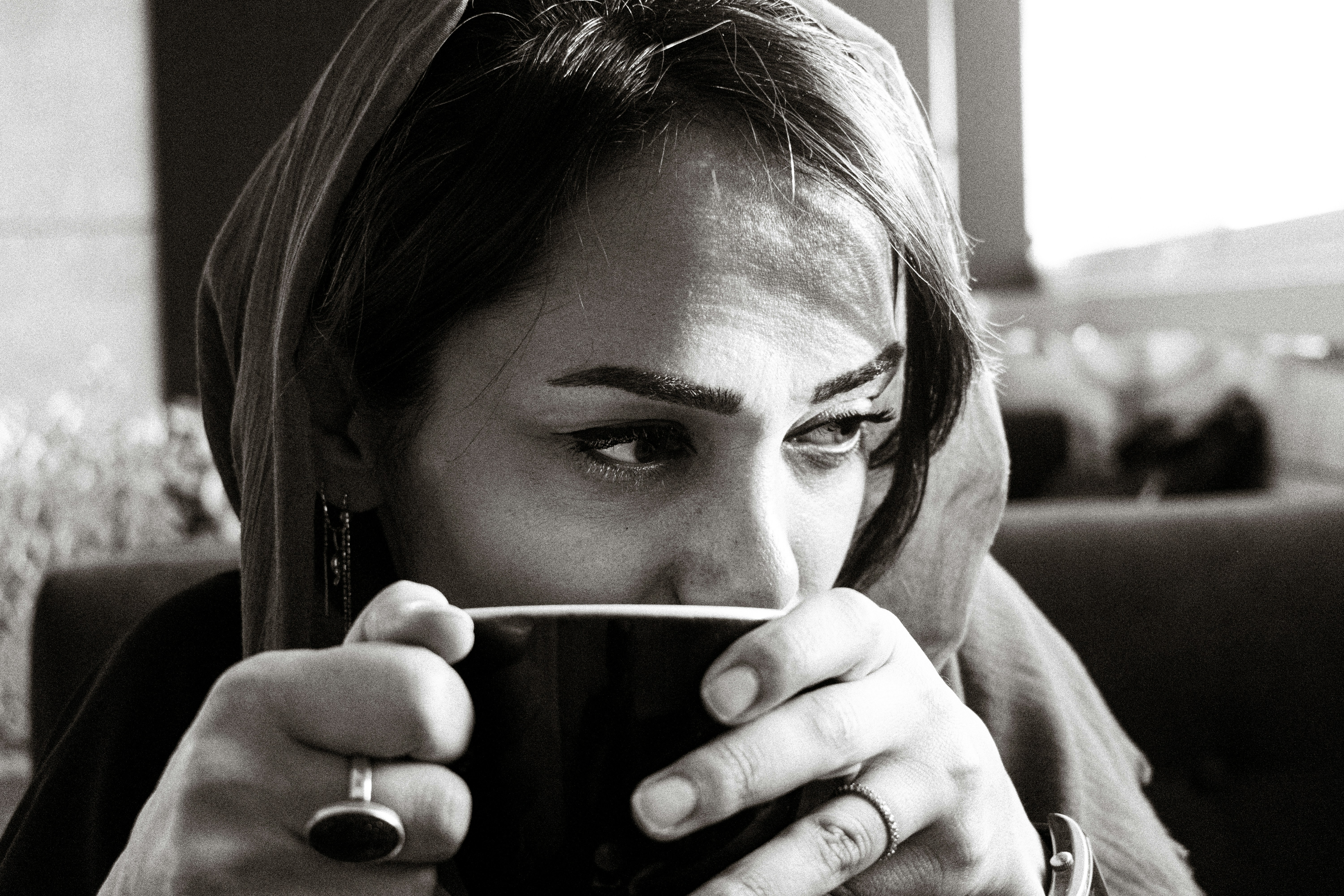 Quiet Gaze over a Cup: A Moment of Secretive Warmth