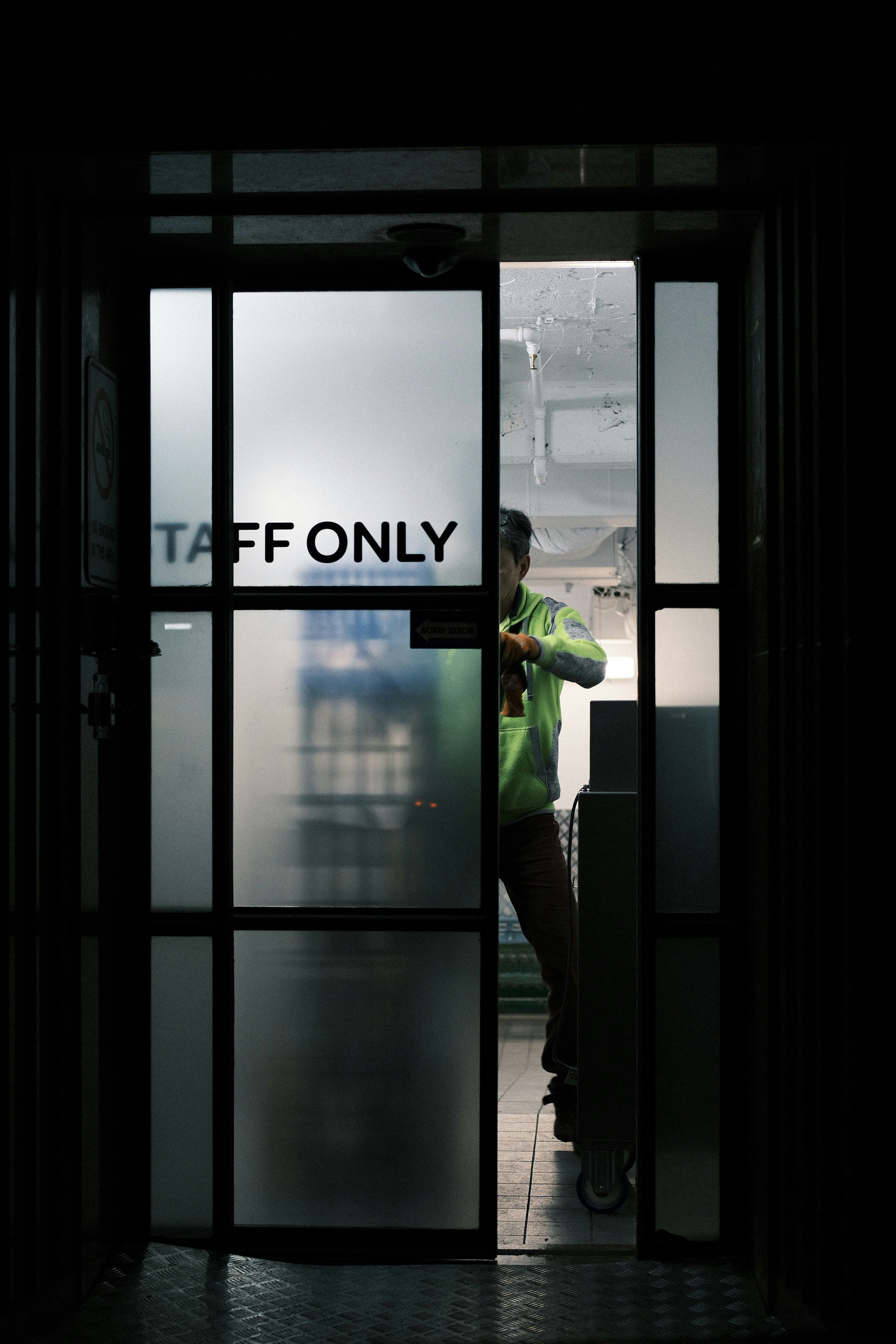 Behind the Glass: Quiet Activity at the Loading Door