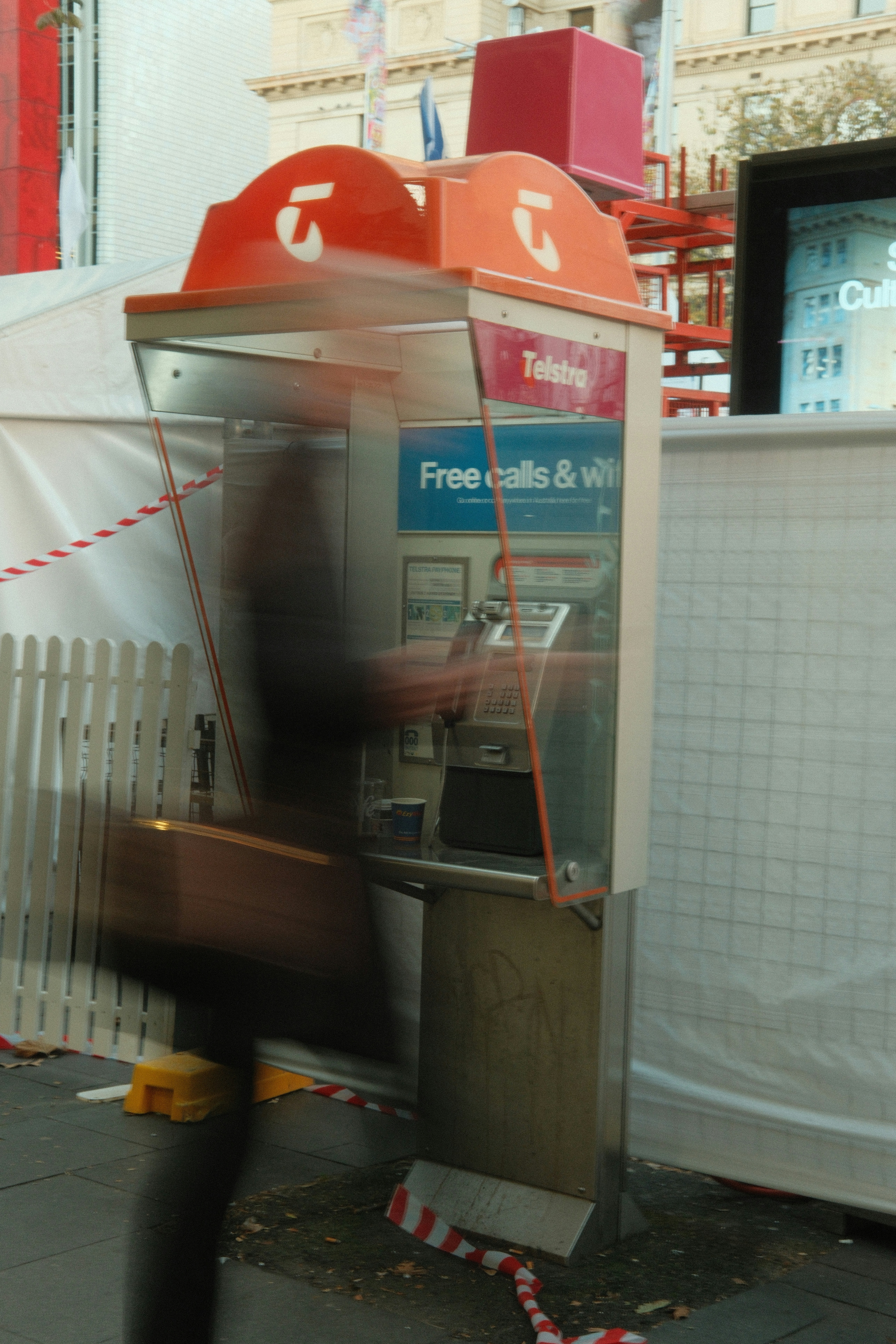 Blurry Messenger: A Ghostly Figure at the Telstra Kiosk
