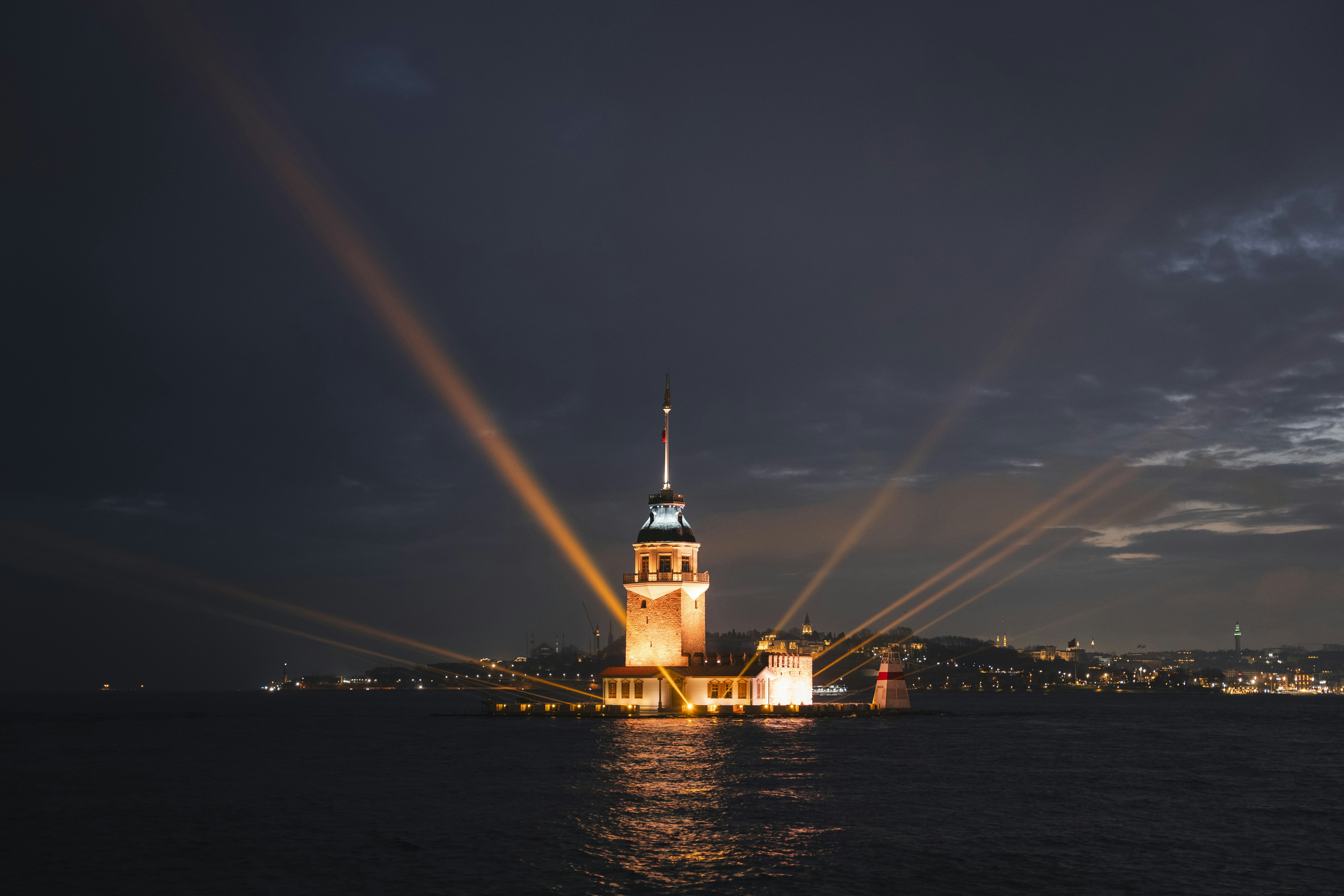 Beacon of the Night: Lighthouse Pierced by Light Beams