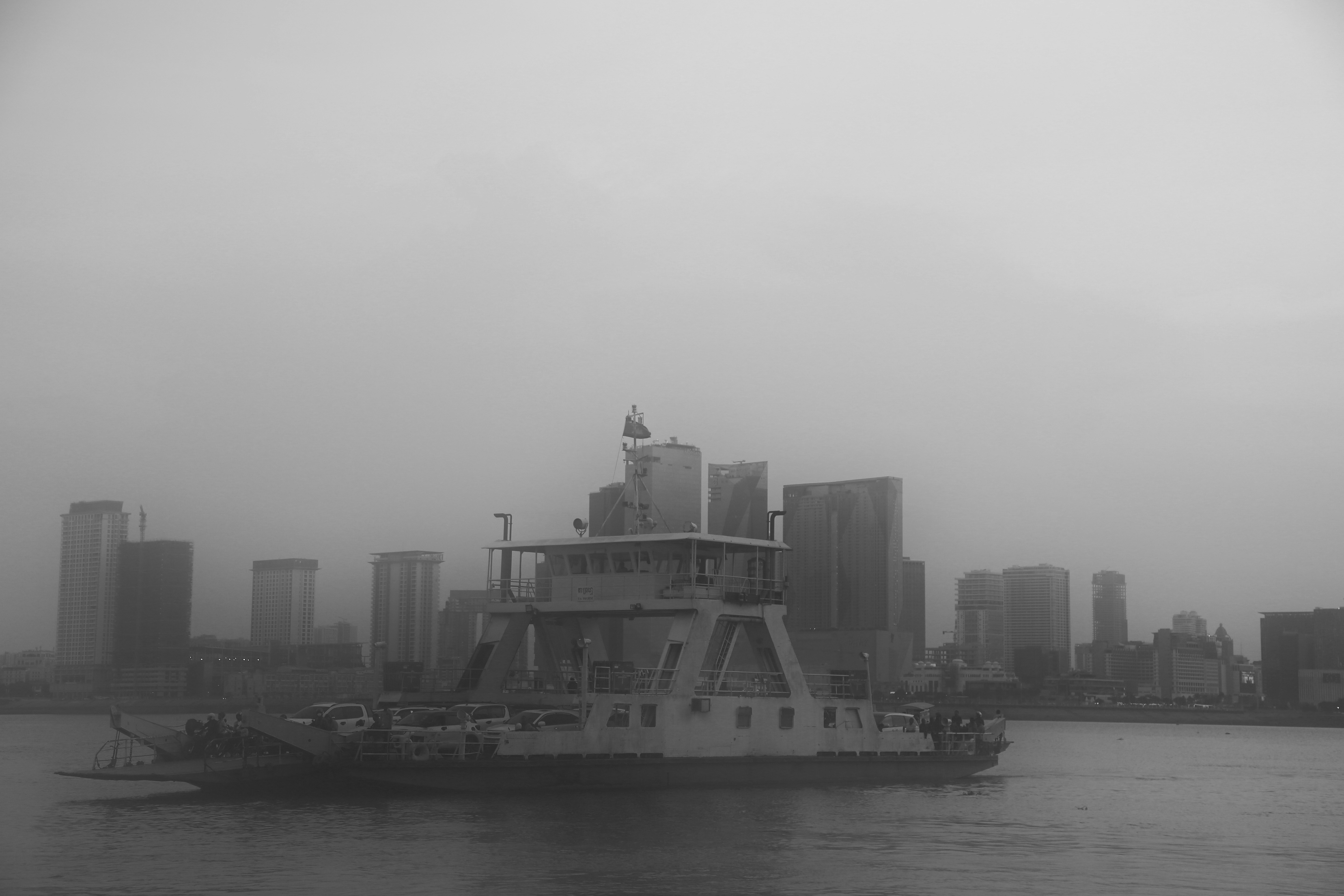 River Tug Under a Quiet Harbor Skyline