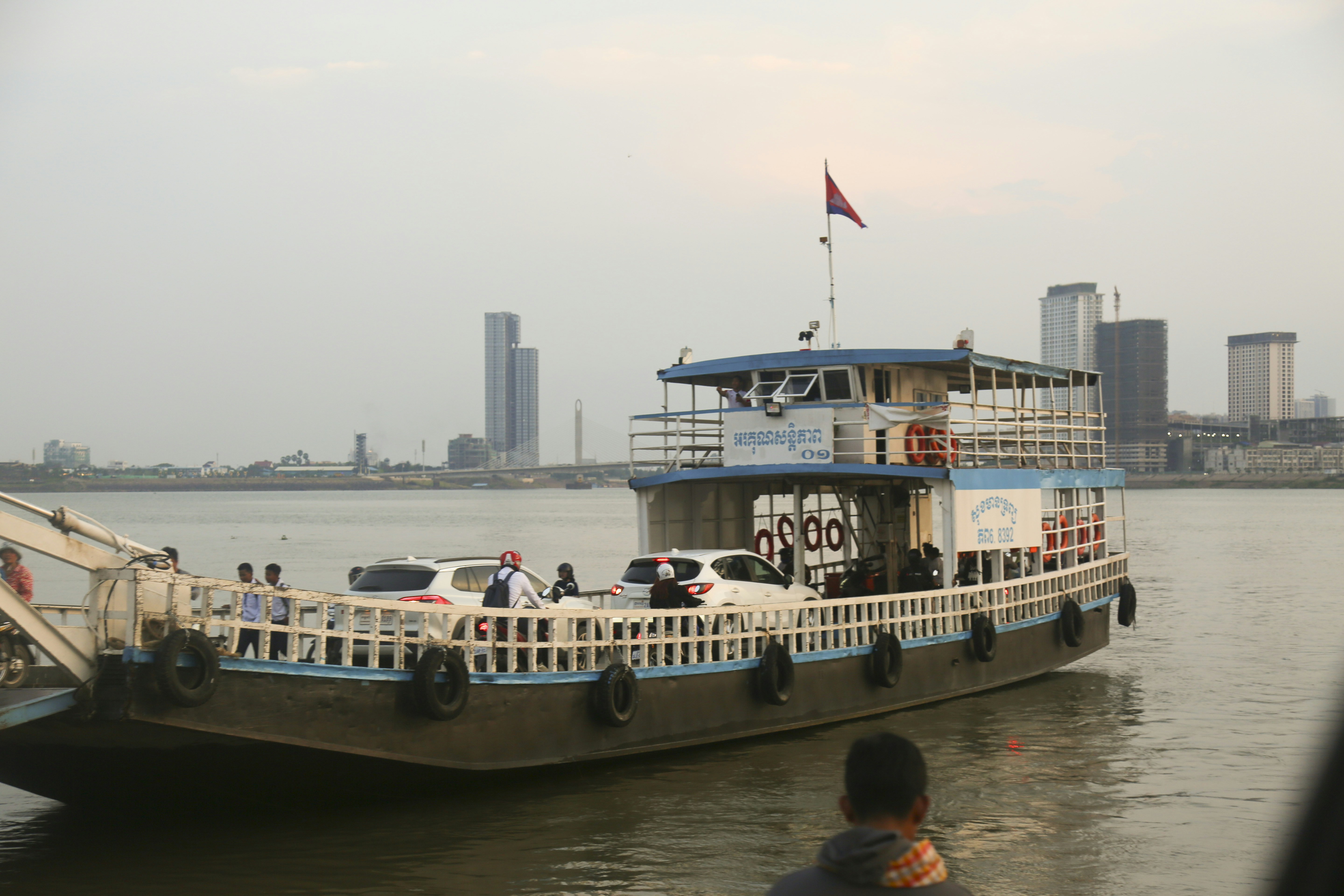 Evening Ferry Break: A City Skyline Watches Over a Busy Waterway