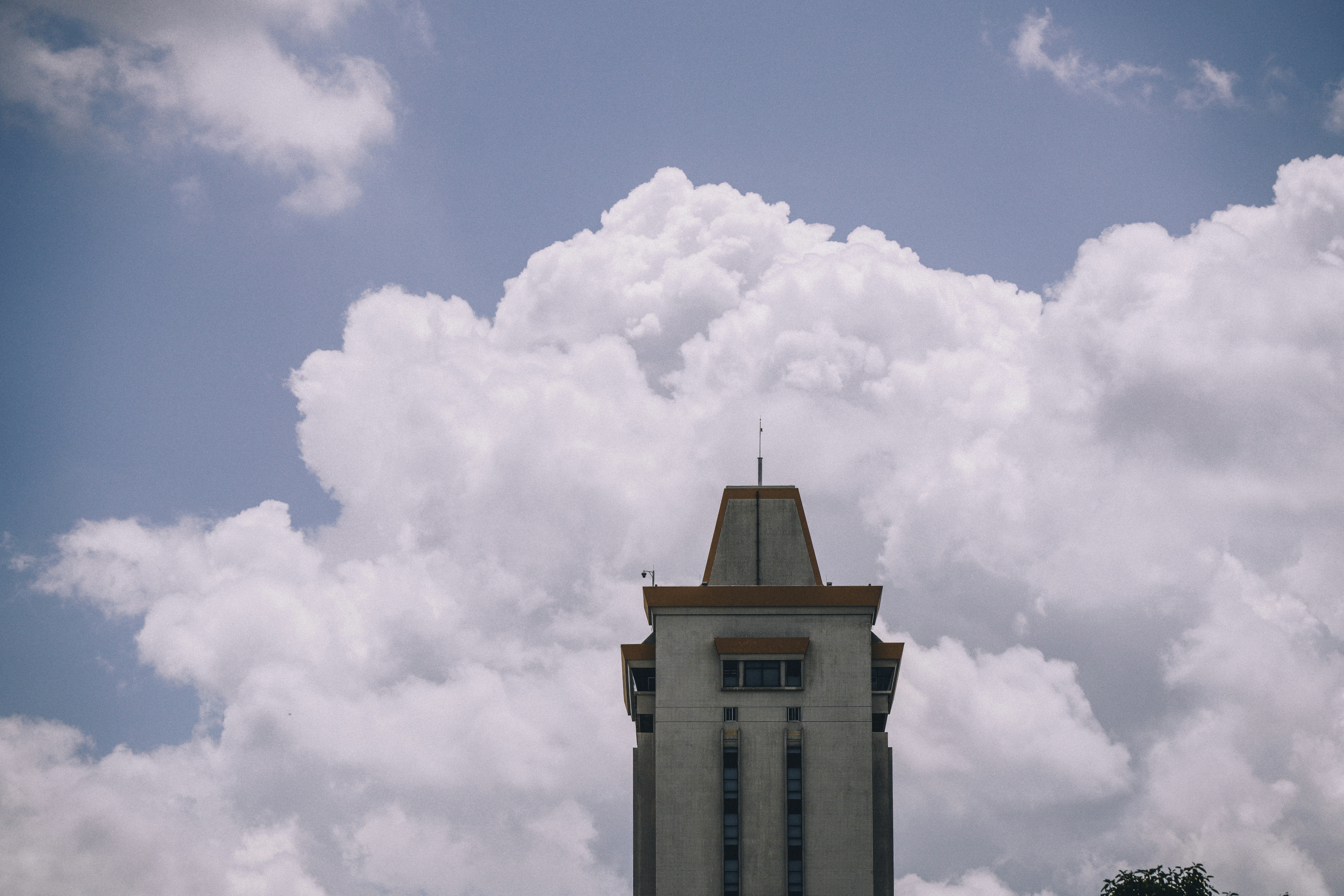 Towering Quietude: A solitary pinnacle against a cottony sky