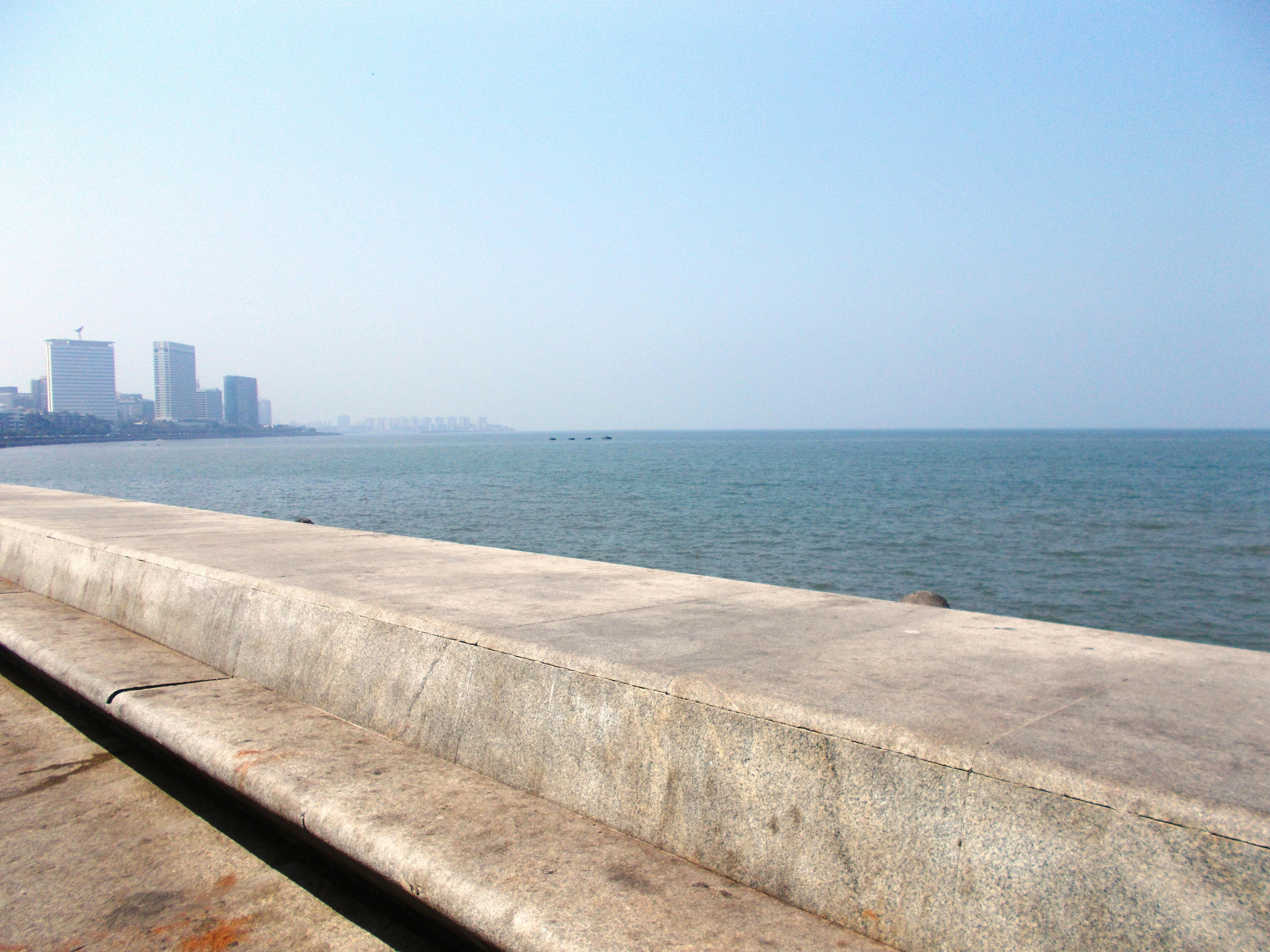 Sea Horizon Over a Concrete Seawall with Distant Skyline