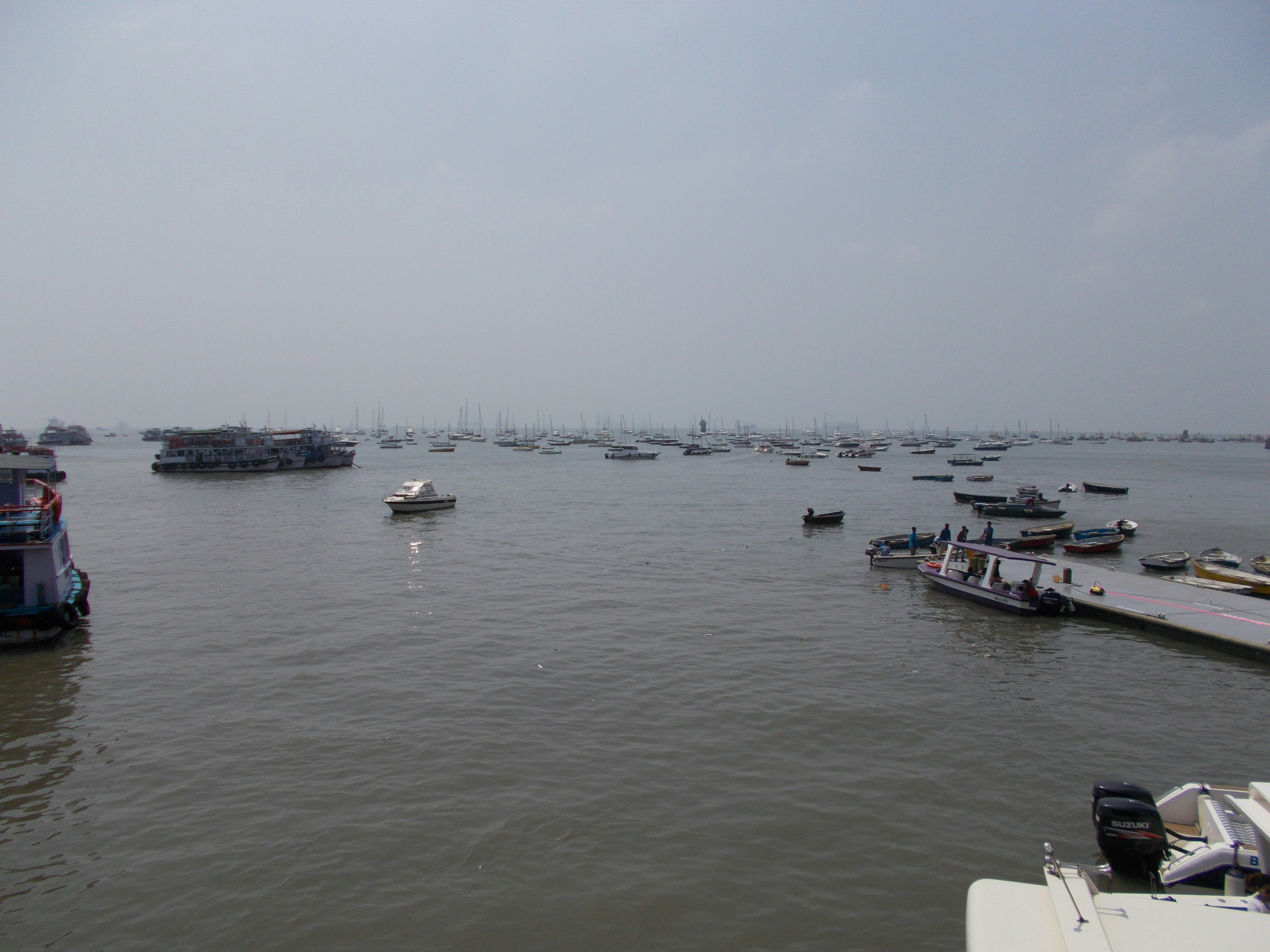 Harbor Mosaic: Boats resting under a hazy sky