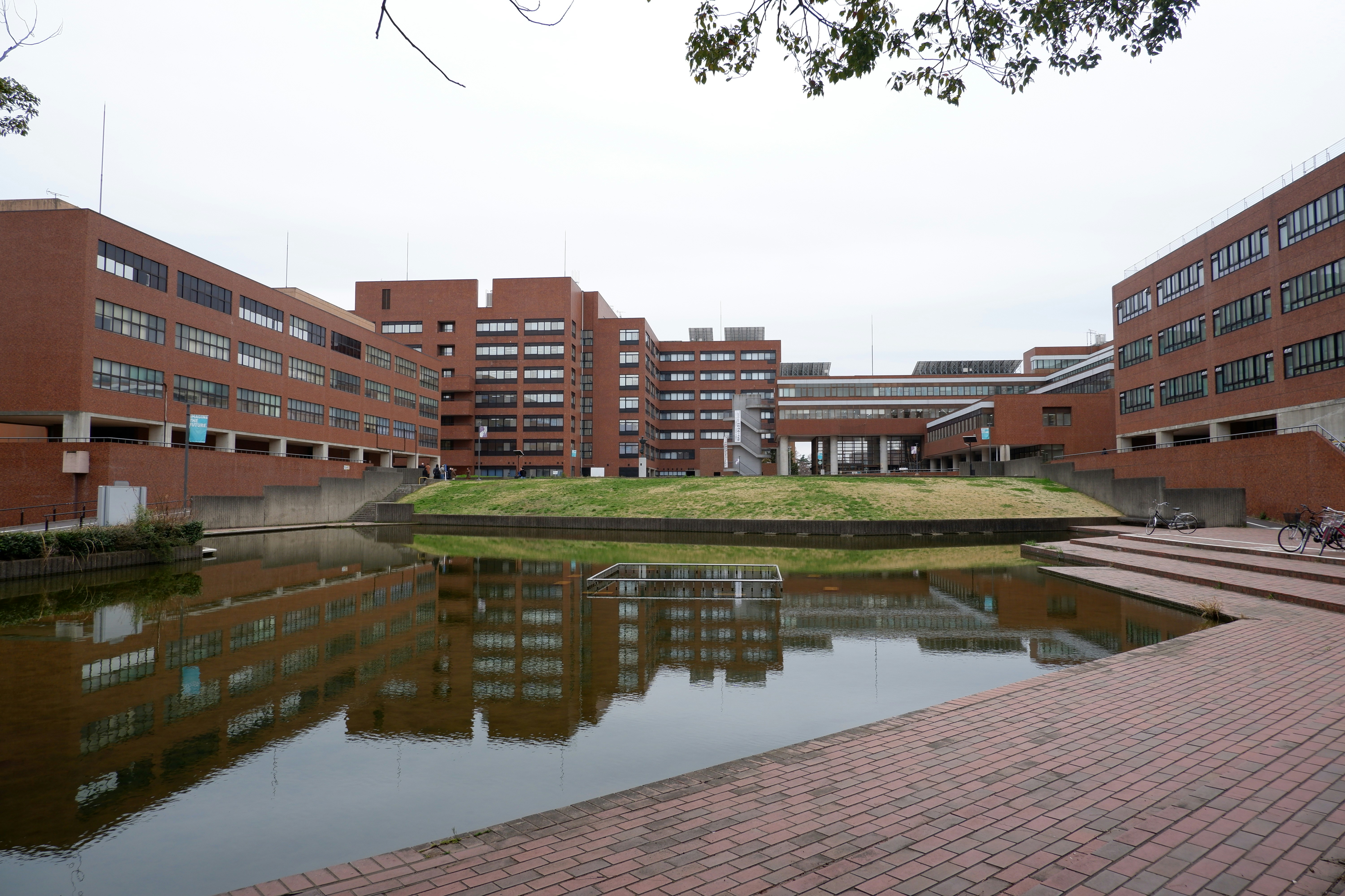 Campus Courtyard Reflections Under a Cloudy Sky