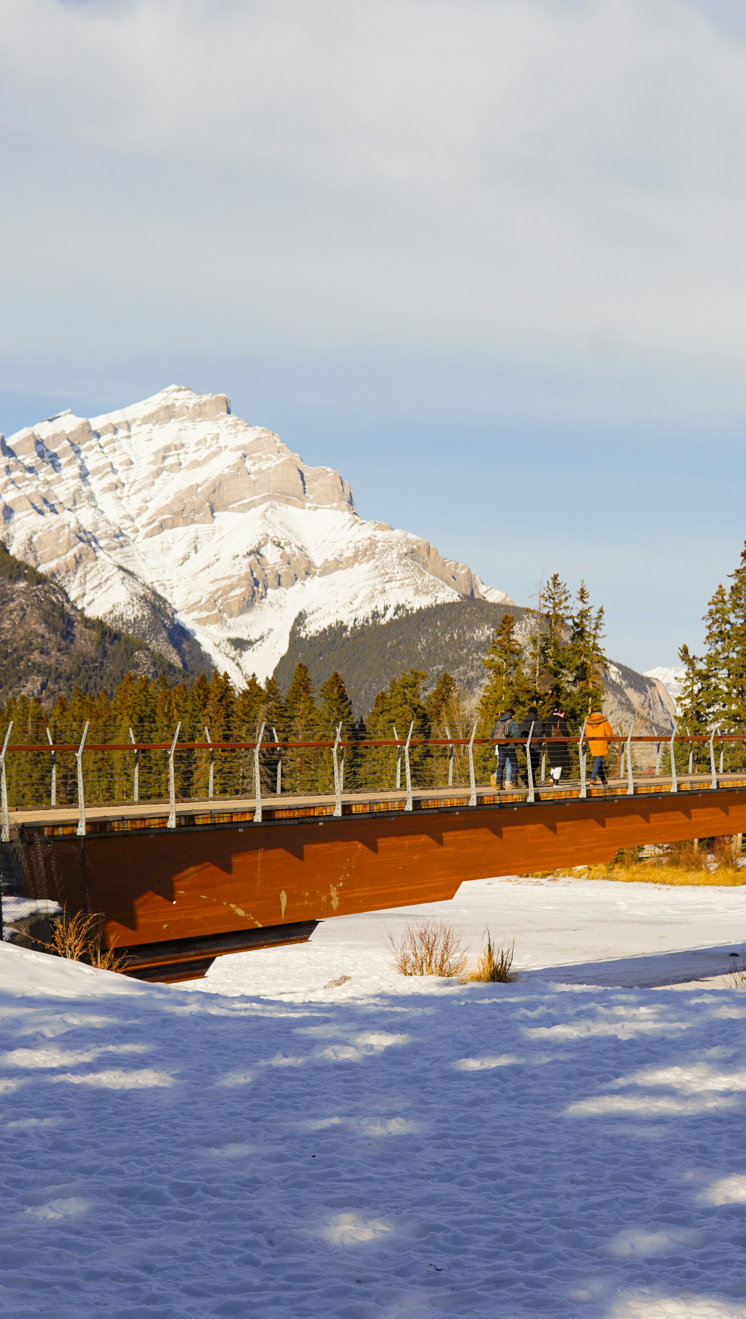 Bridge over Snow-Laced Valley with Snowy Peaks
