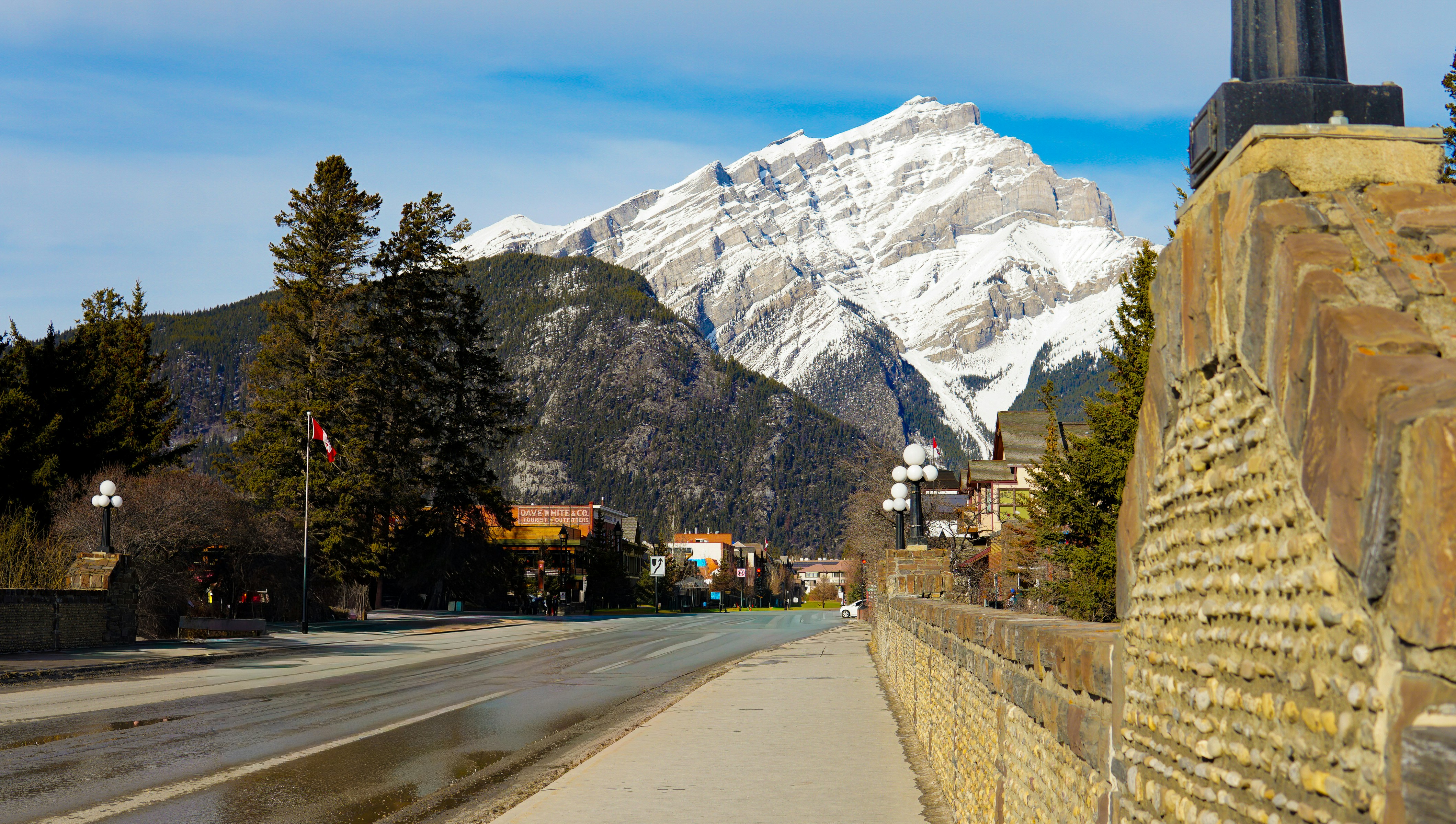 Snow-capped Peak Overlooked by a Quiet Riverside Promenade