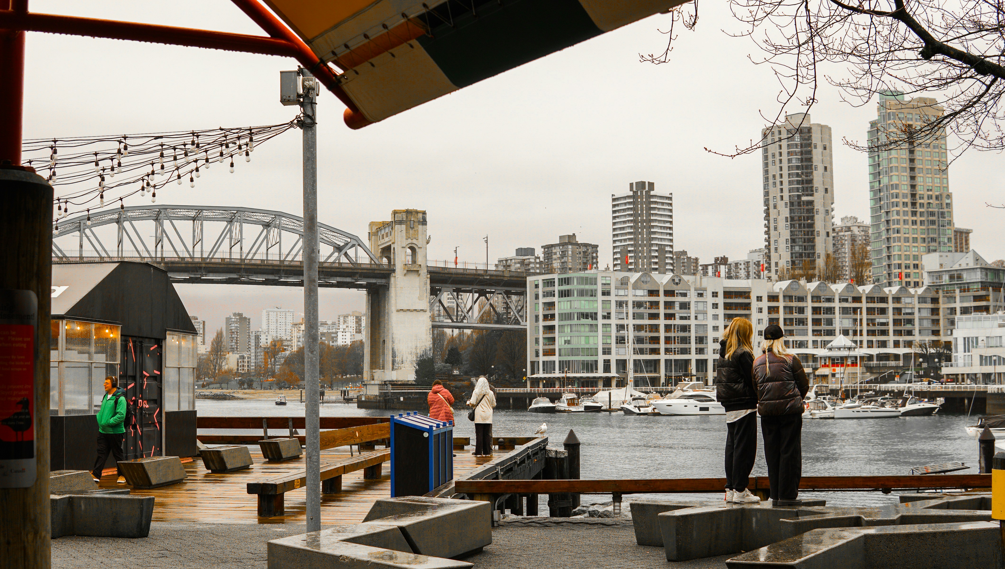 Couple on the waterfront overlook with city and bridge backdrop