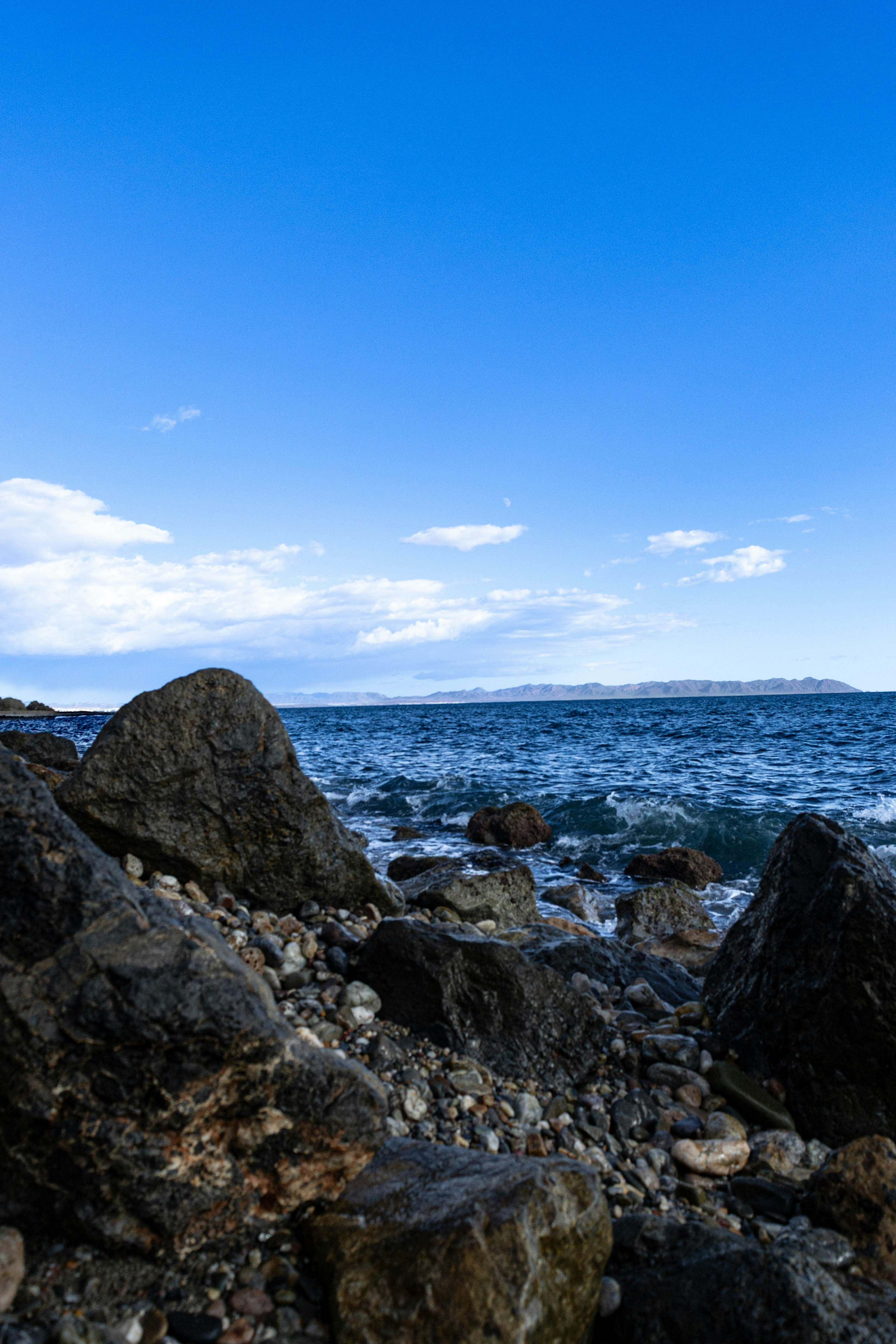Rugged shoreline under a clear blue sky