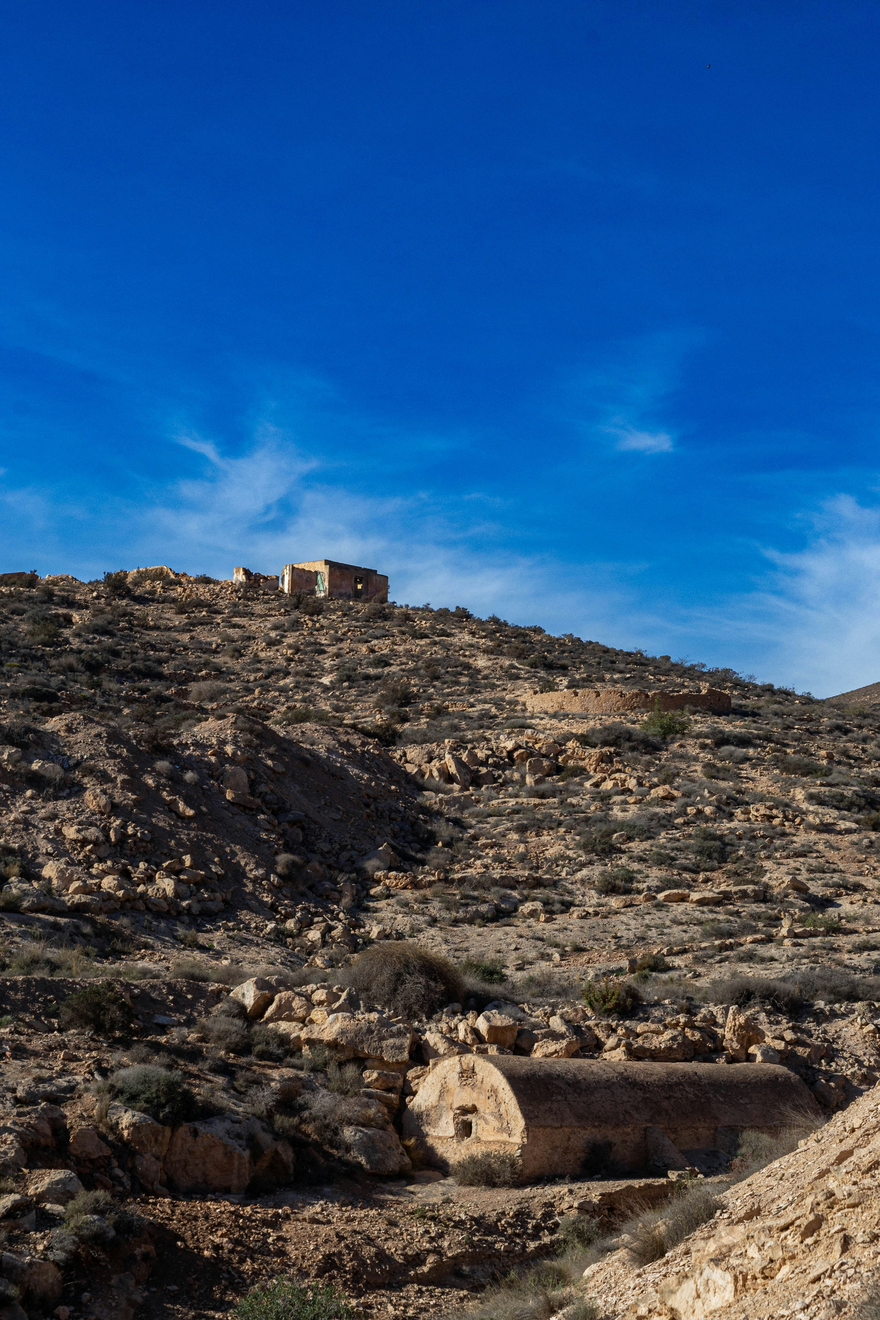Ridge-top ruins under a clear blue sky