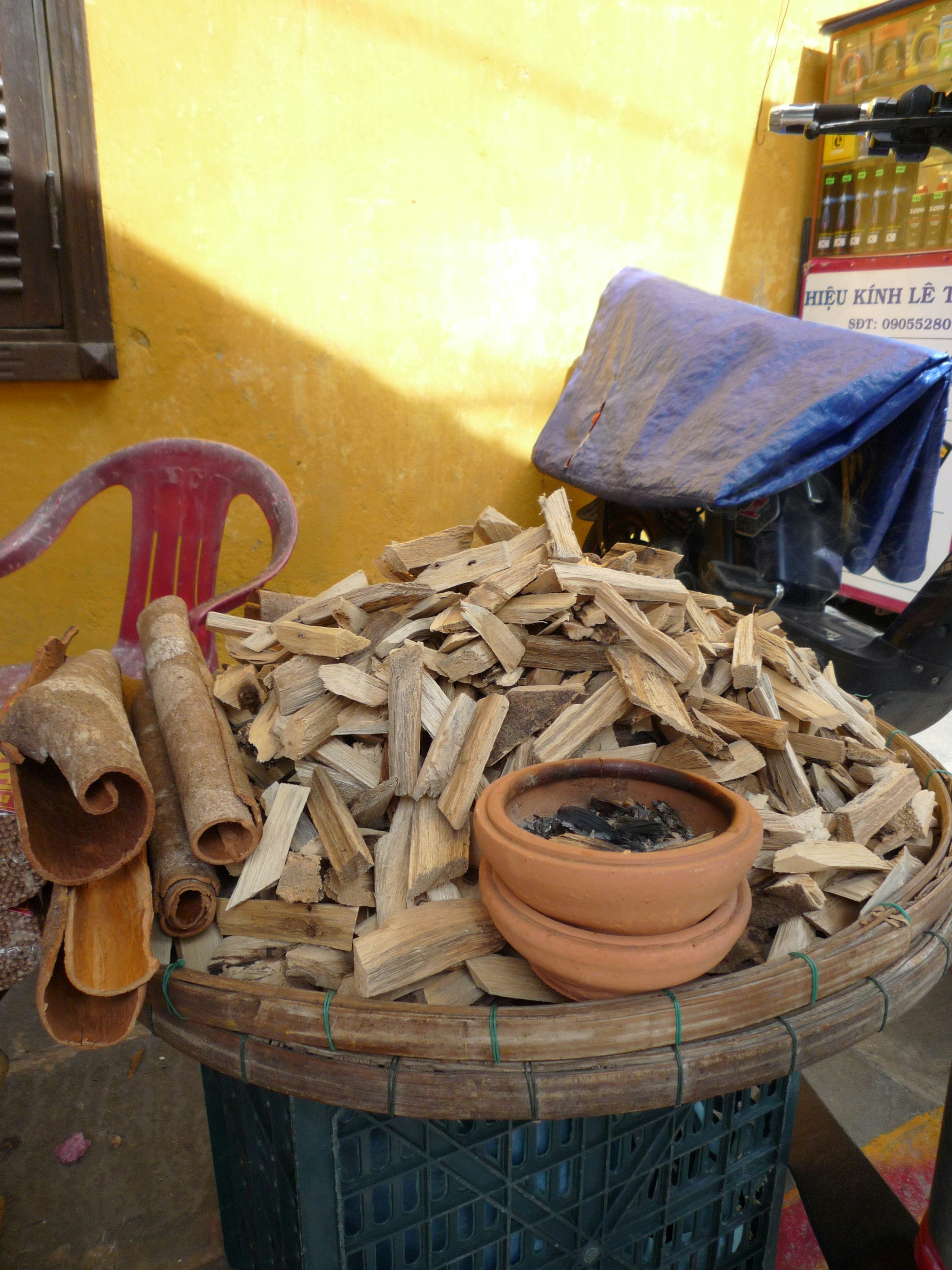 Pile of Firewood and Clay Pot on a Market Stall