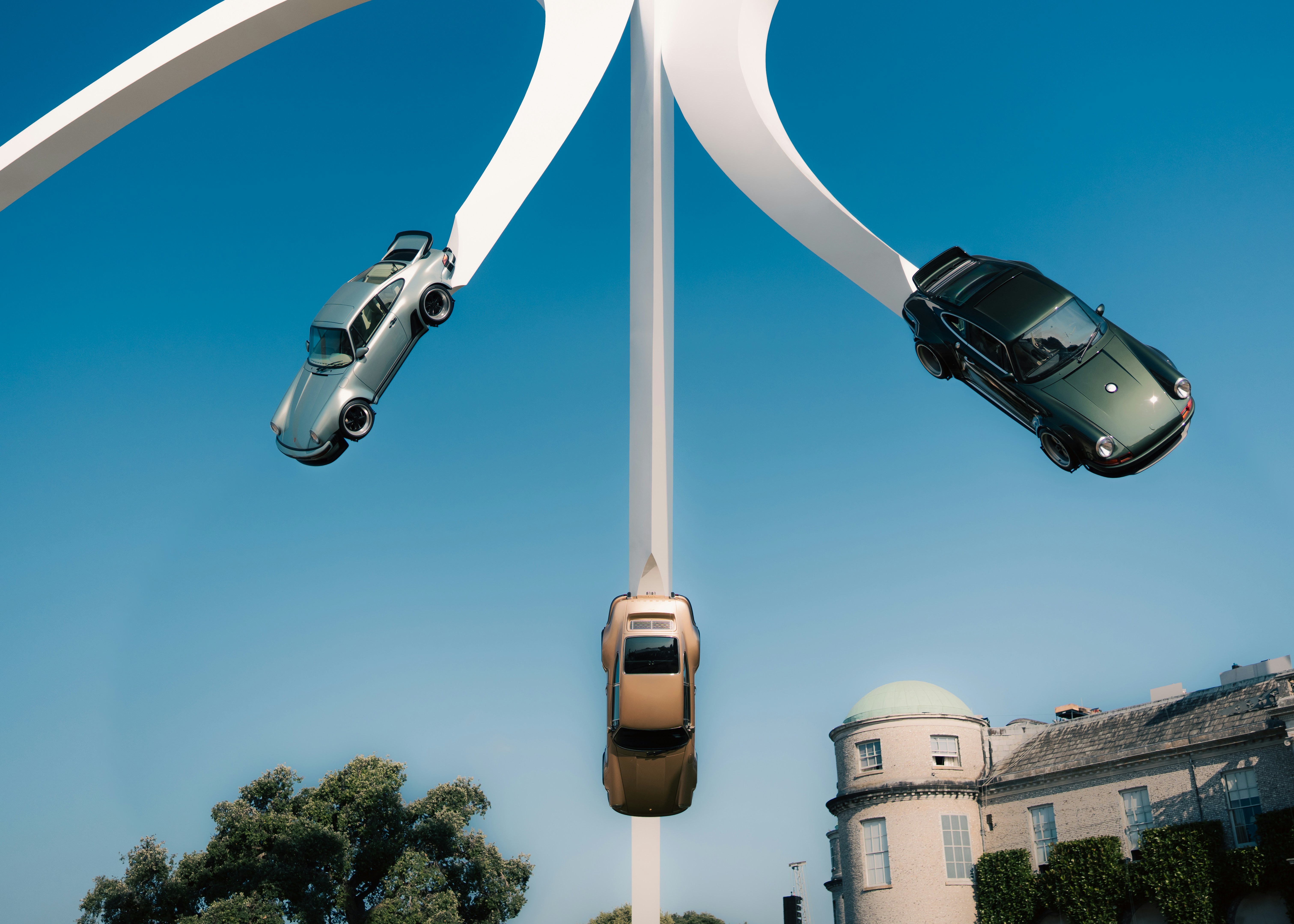 Aerial Loop: Cars in Freefall Above a Classic Campus Facade