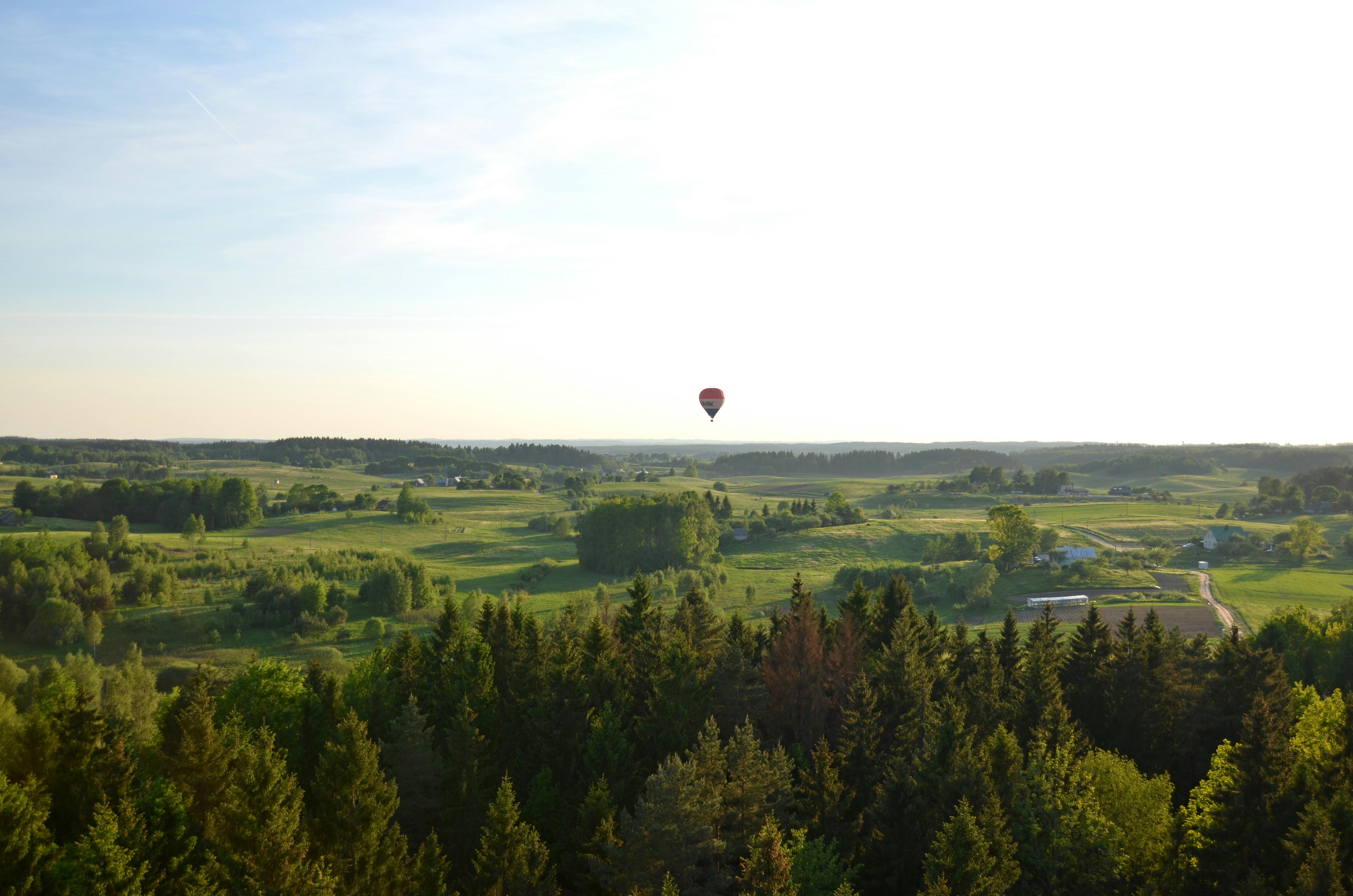 Balloon Above Rolling Fields at Dusk
