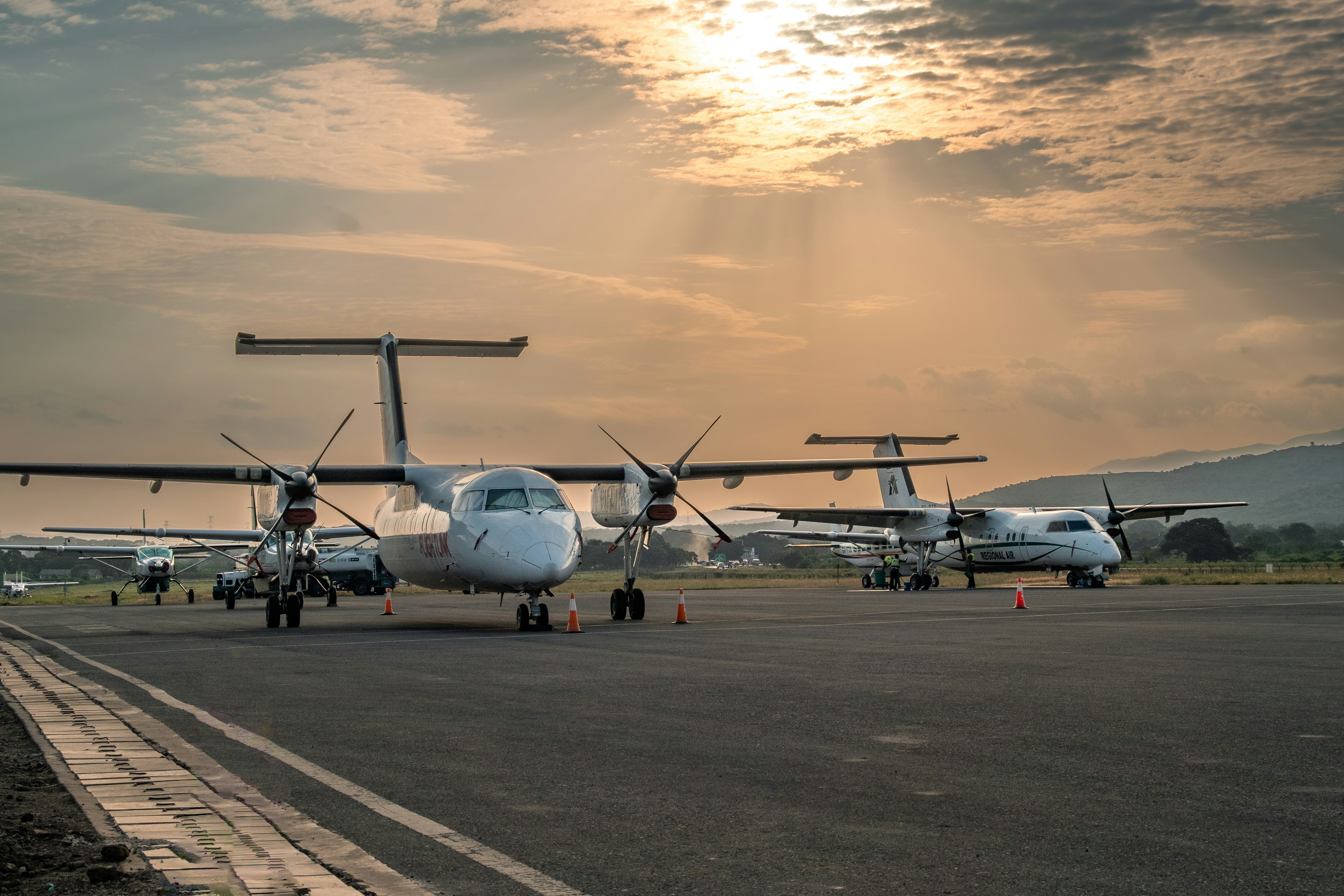 Dawn on the Tarmac: Twin Prop Transporters Rest At Quiet Gate
