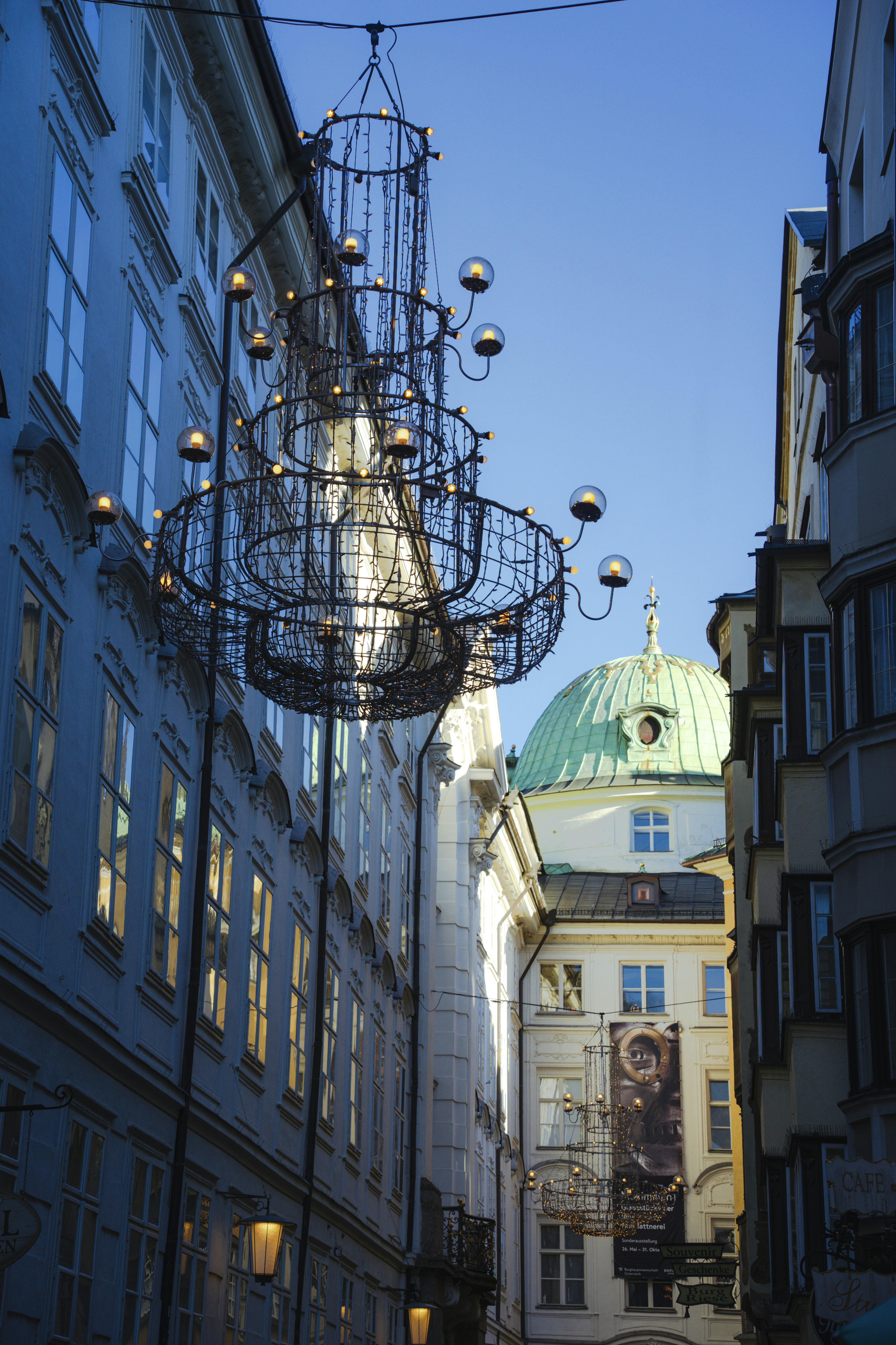 Chiming Lights Over a City Street Beneath a Verdant Dome