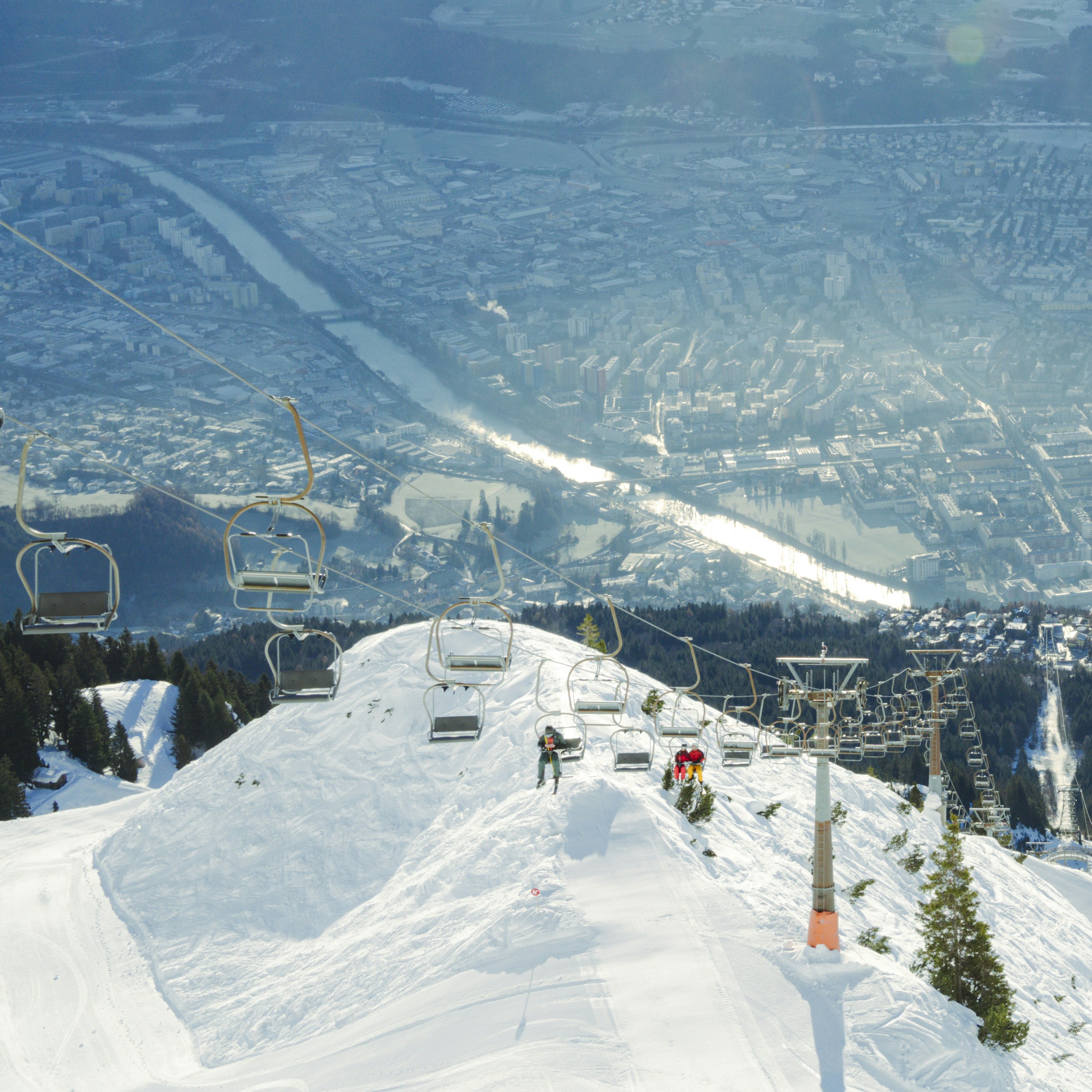Snow-Chase on the Chairlift: Riders Climb the Peak