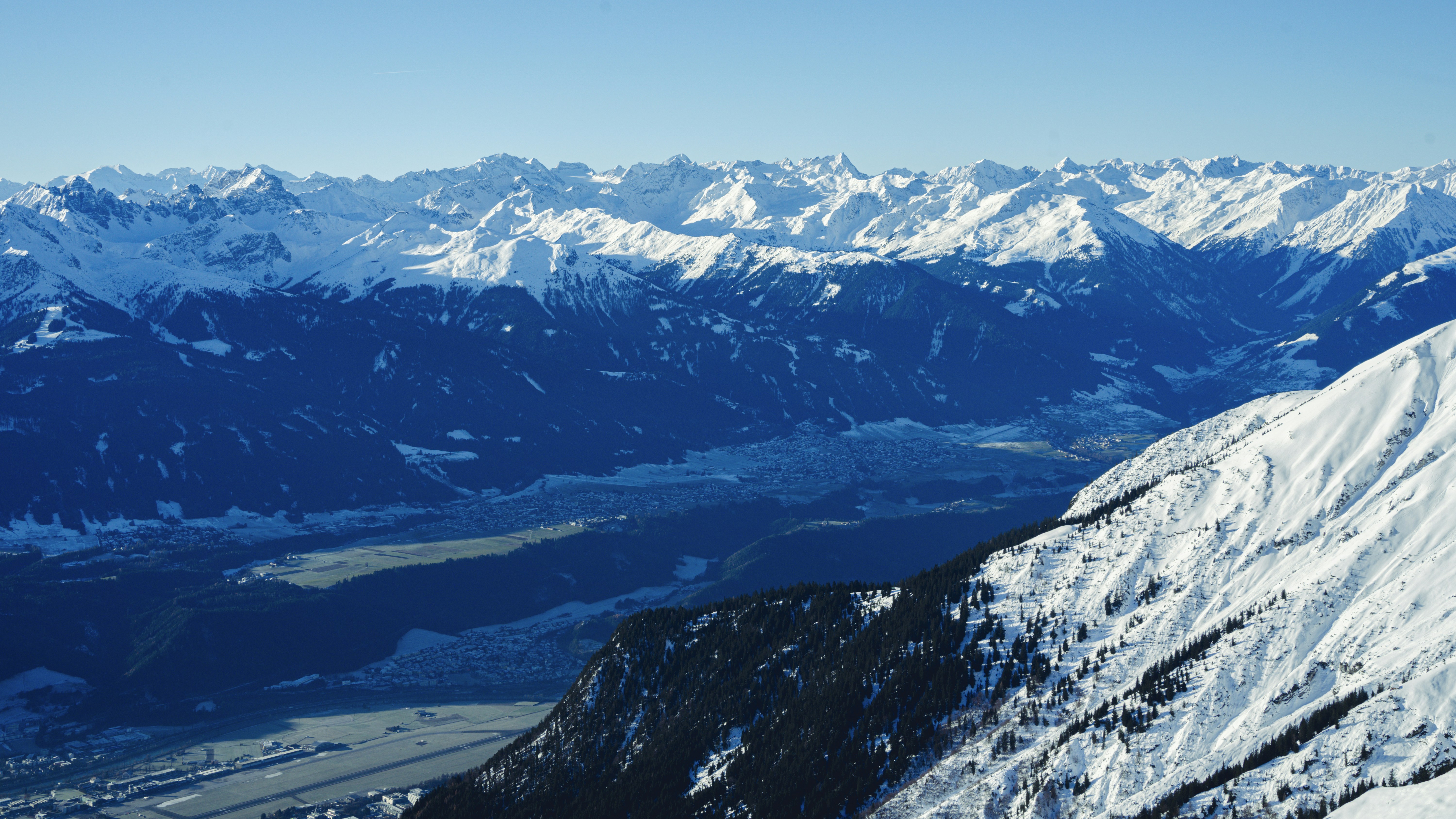 Snowbound Spine: A Panoramic Alpine Crest bathed in blue light