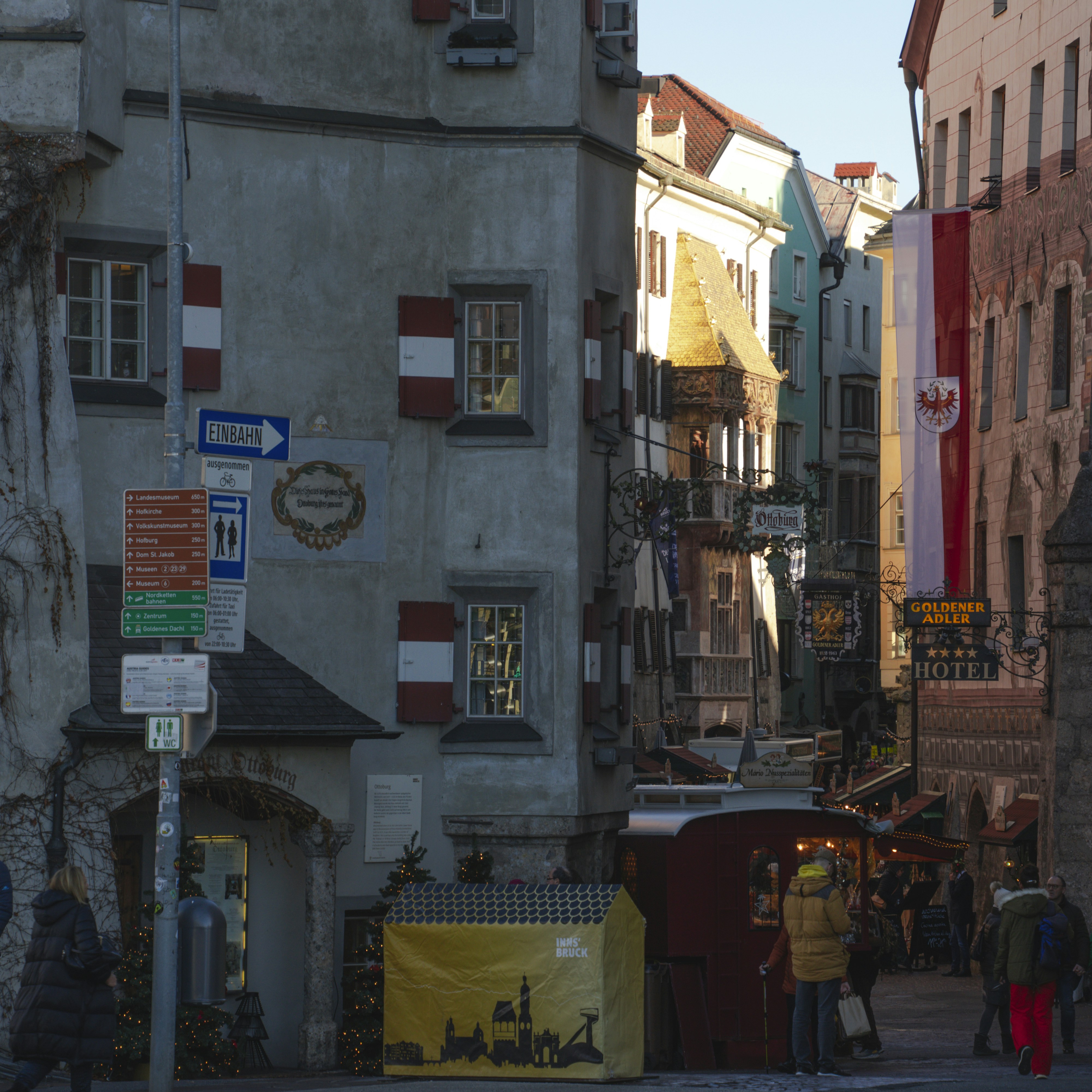Cobbled Lane Under Flags: A Quiet Street of Hidden Hotels and Warm Lights