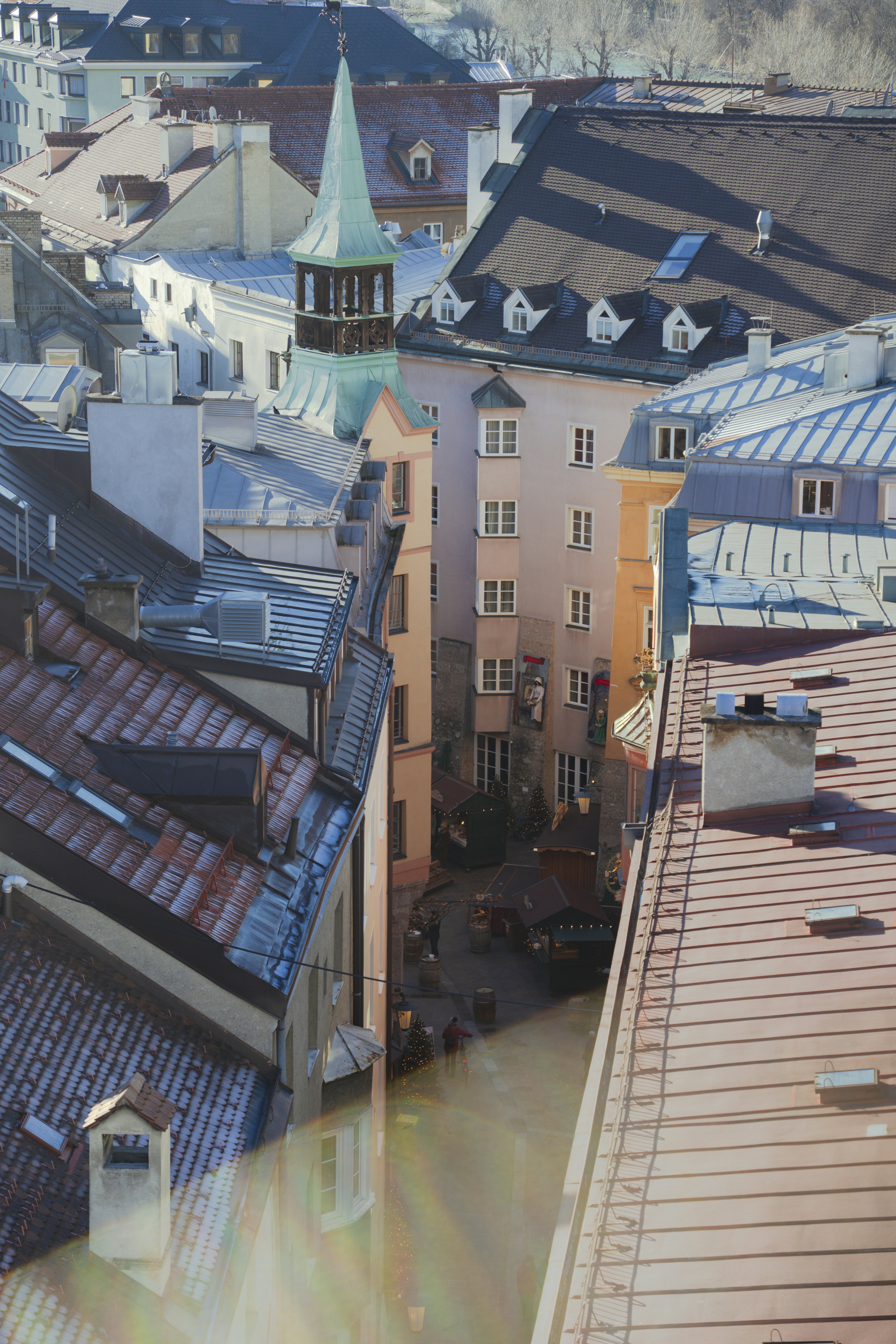 Aerial Alleyway: Central Clock Tower Framed Between Rooftops