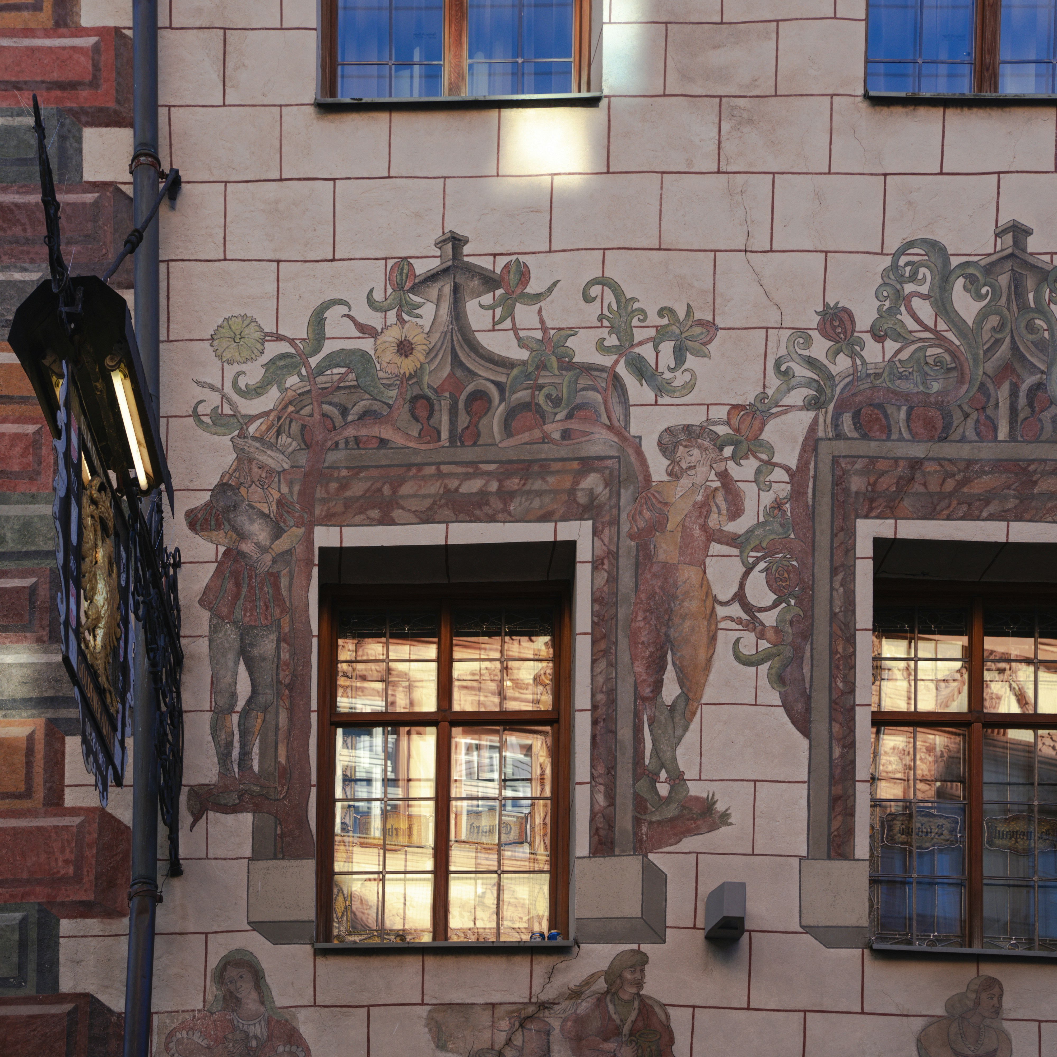 Muraled Facade: Windows Framed by Florid Allegory