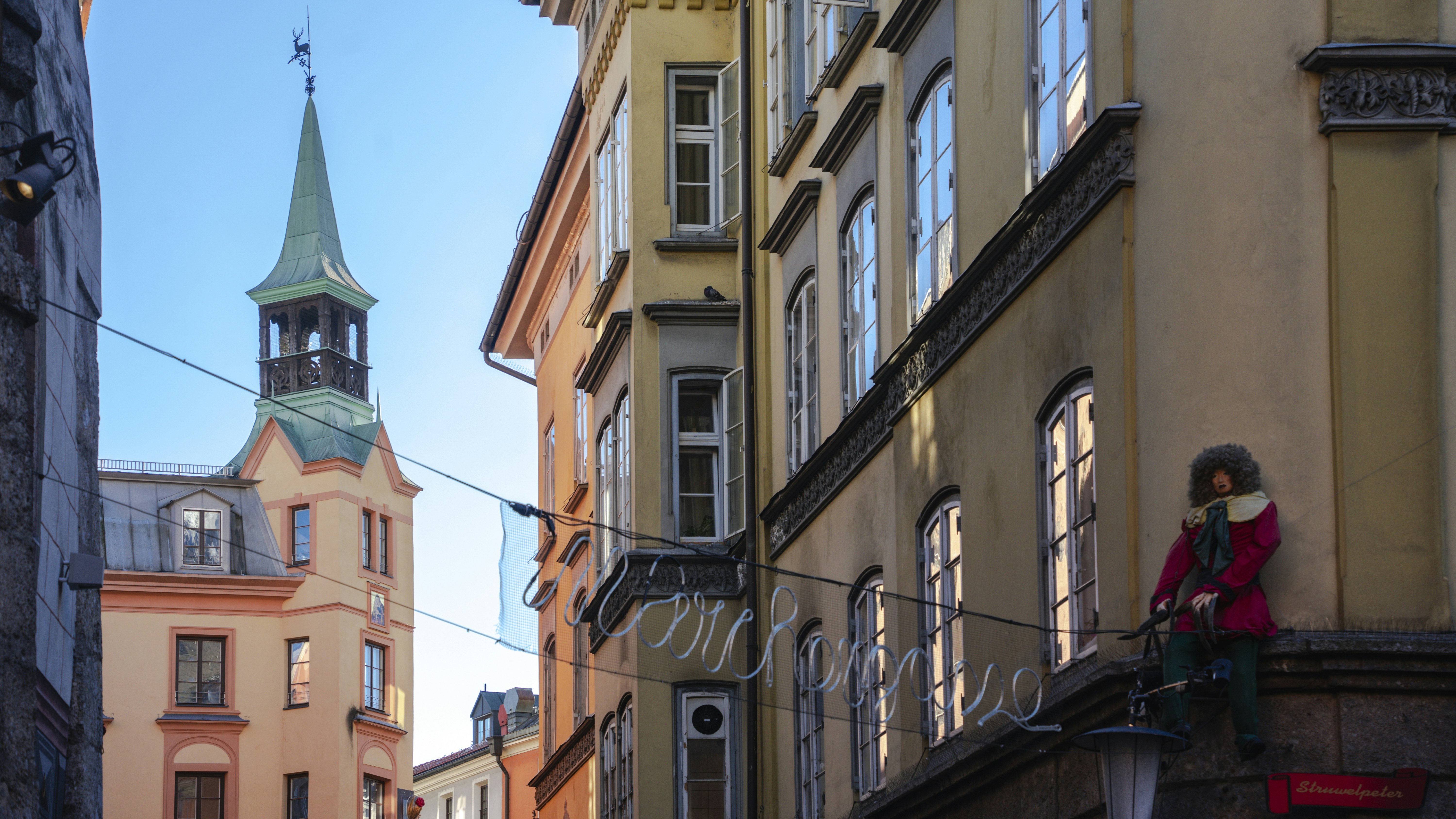 Sunlit European Alley: A Peek at Historic Facades