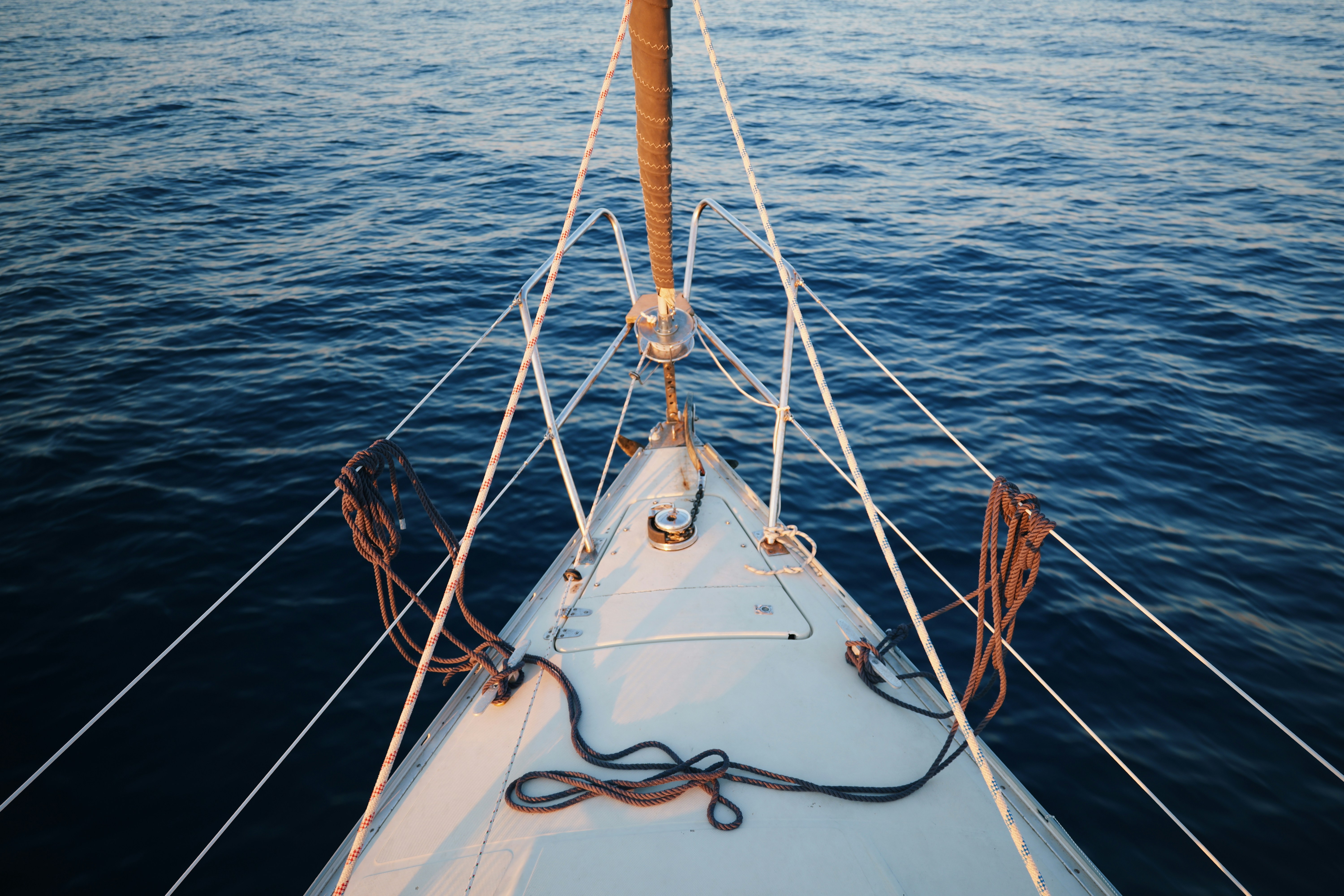 Bow into the Blue: A Sailboat’s Nose Cutting Through Quiet Seas
