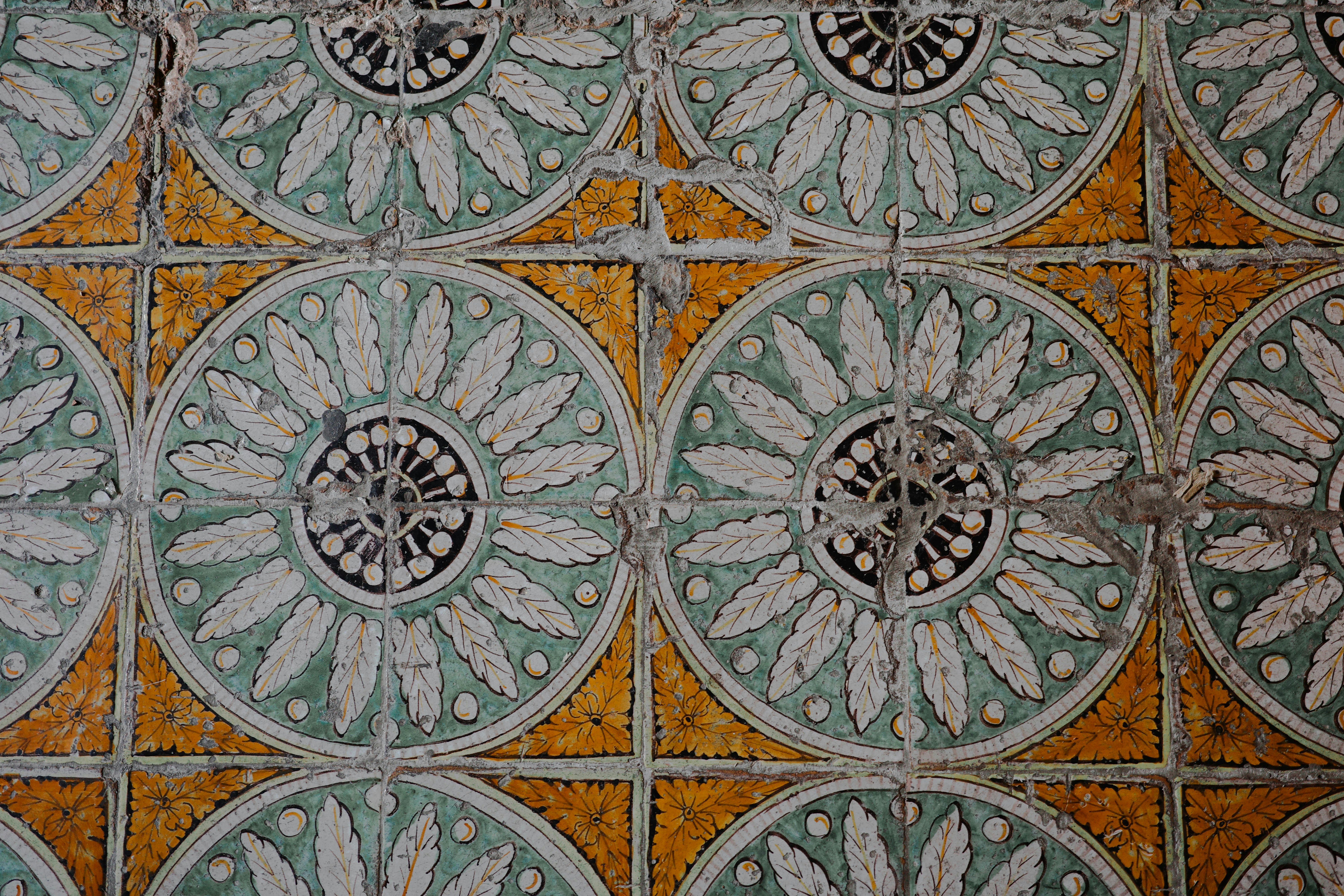 Ornate Circular Tiles: Repeating Mint Motifs in Earthy Mosaic