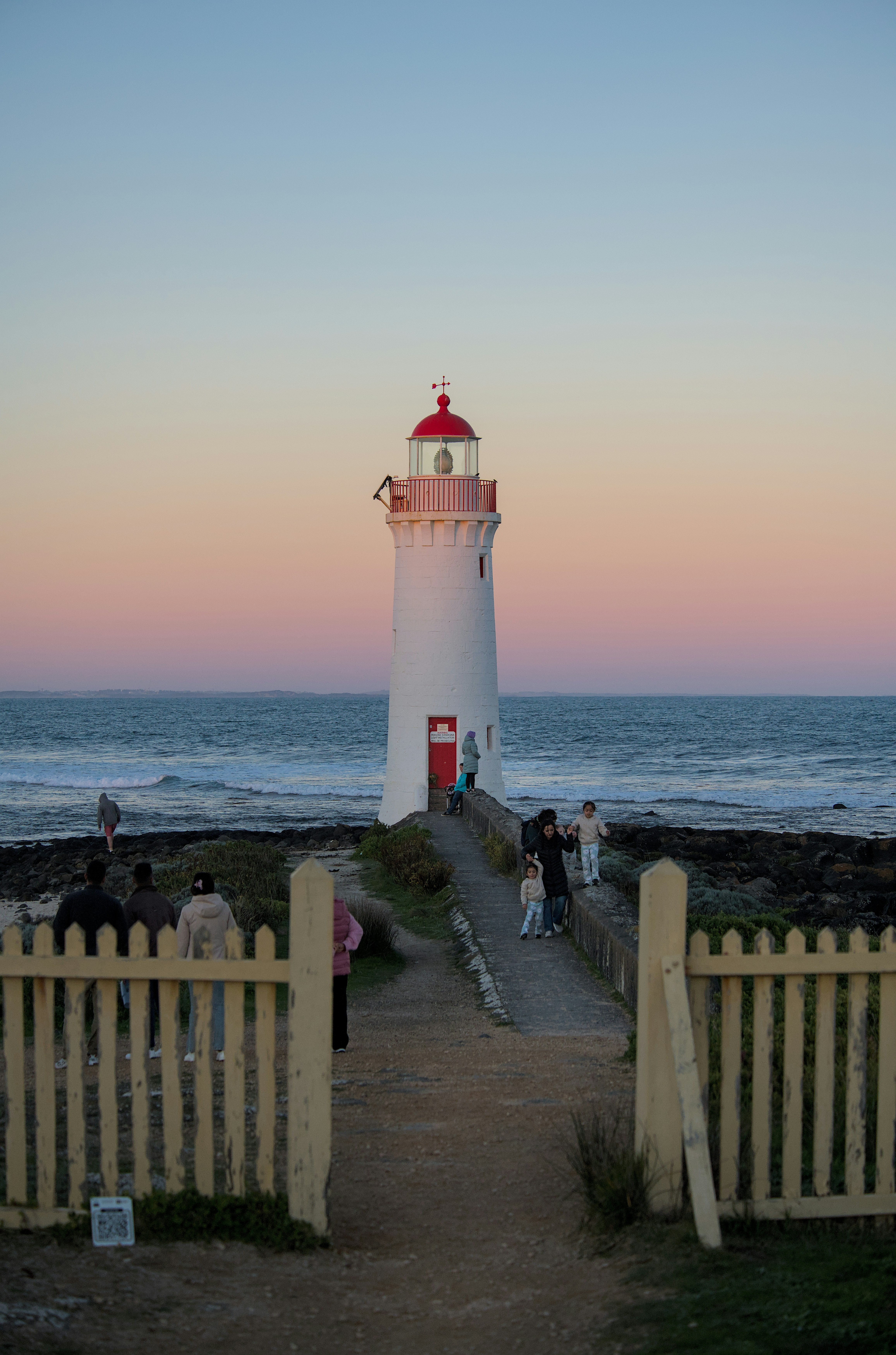 Lighthouse at Dusk: Sentinel Over Calm Seas