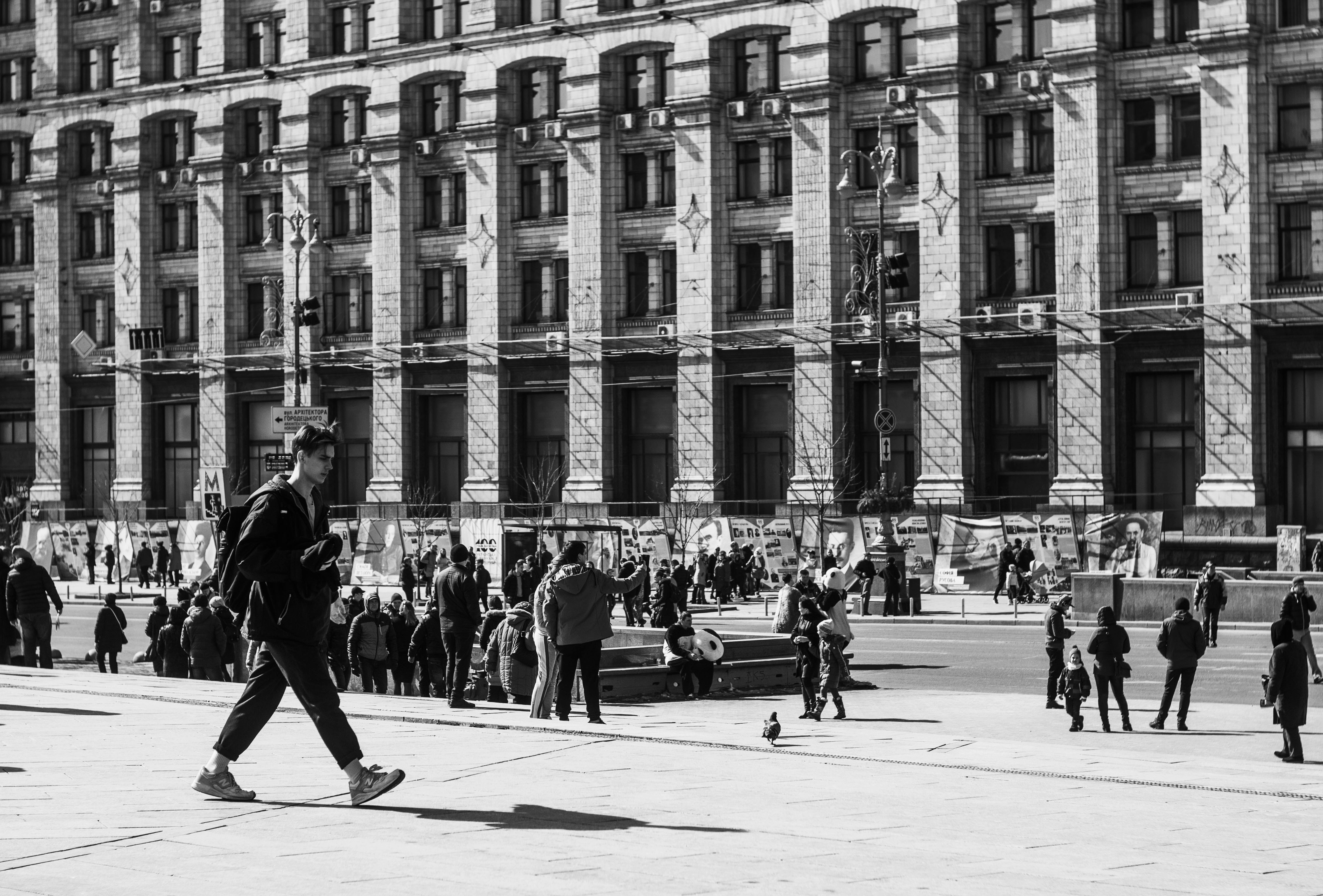 Stride in the Square: A Quiet Moment Among the City’s Chorus