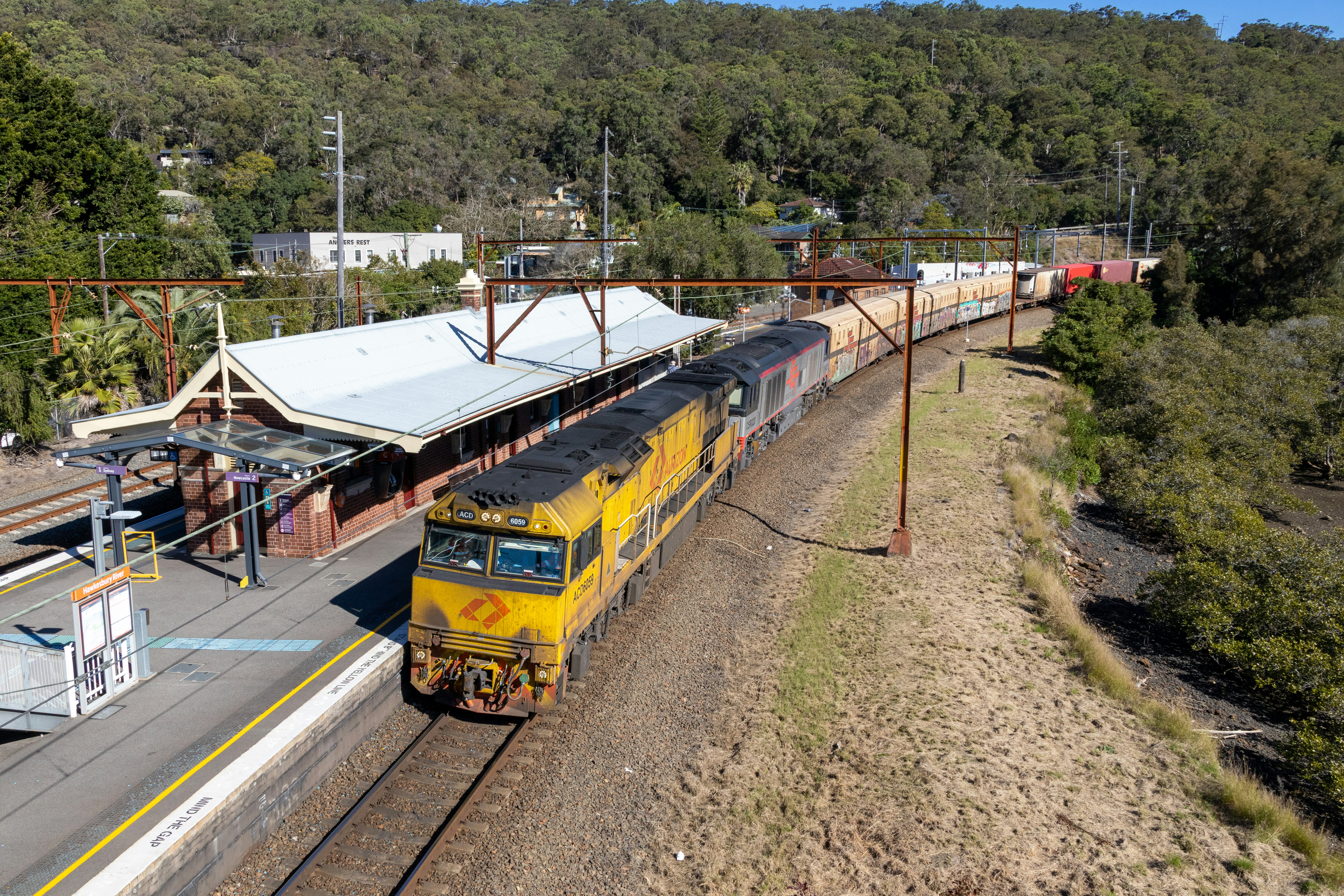 Heading Toward the Horizon: A Golden Locomotive on a Quiet Inland Rail Line