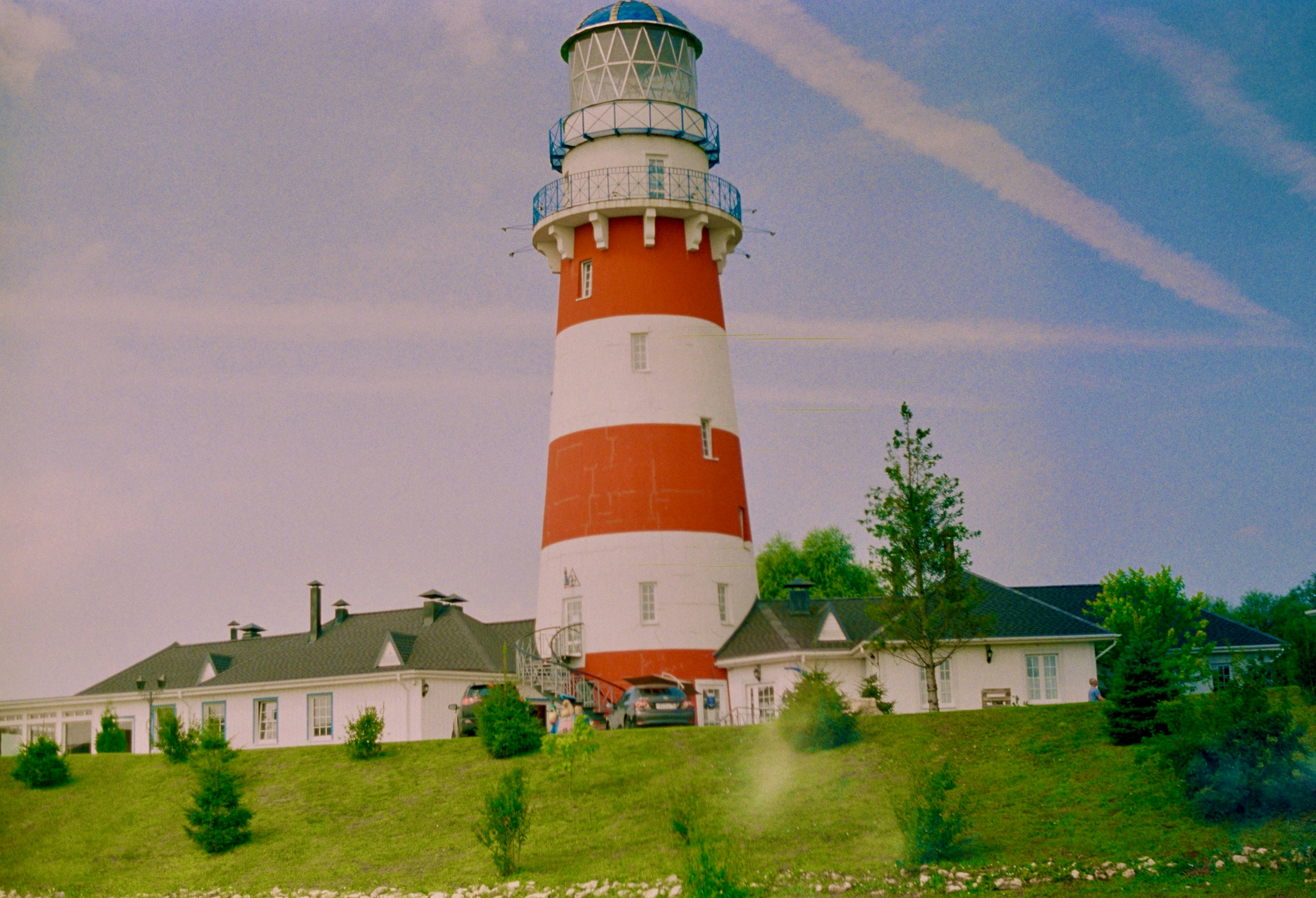 Striking Coastline Beacon: Red and White Tower Under a Wide Sky