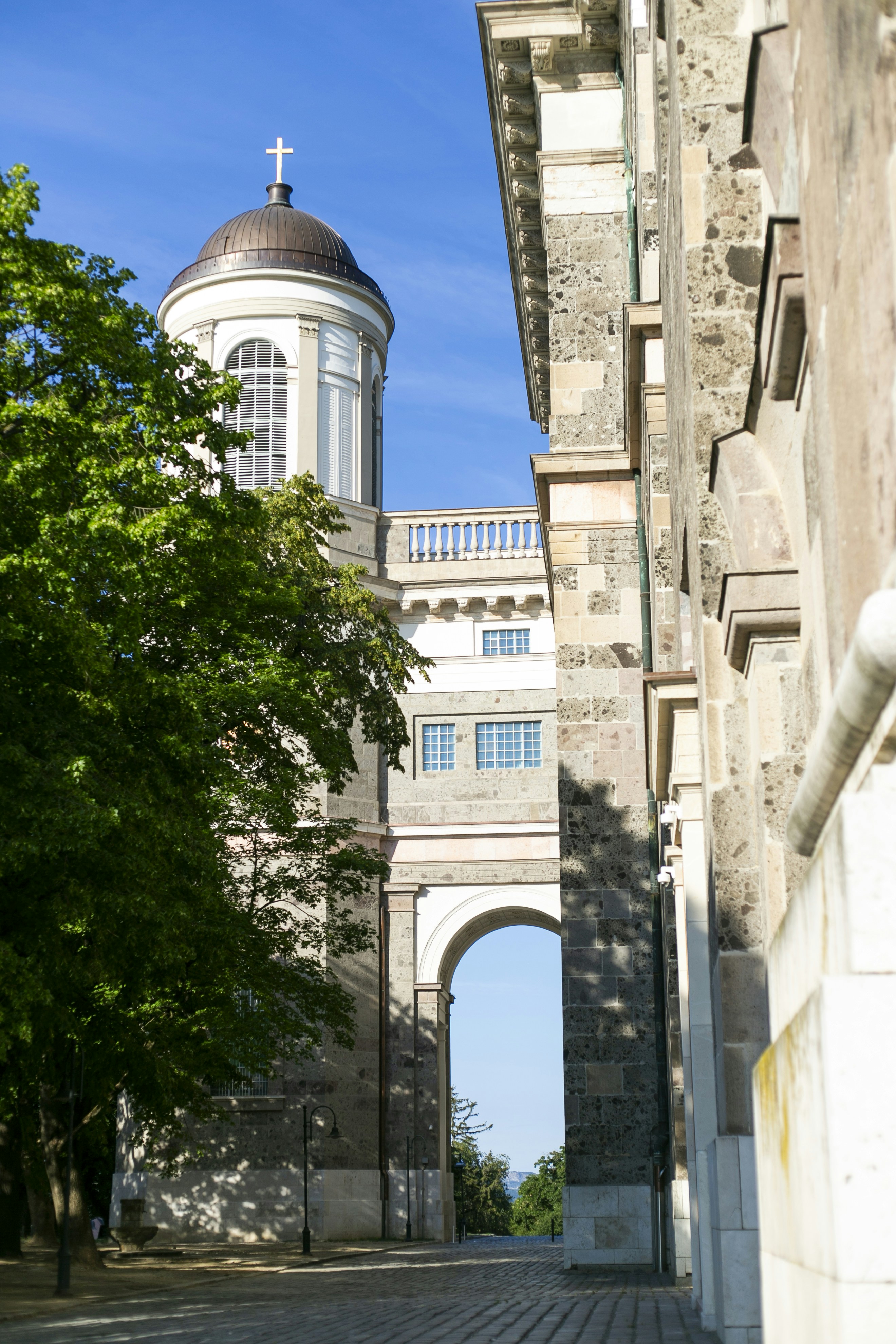 Stone Archway Lead: A Narrow Street Framed by a Historic Clock Tower