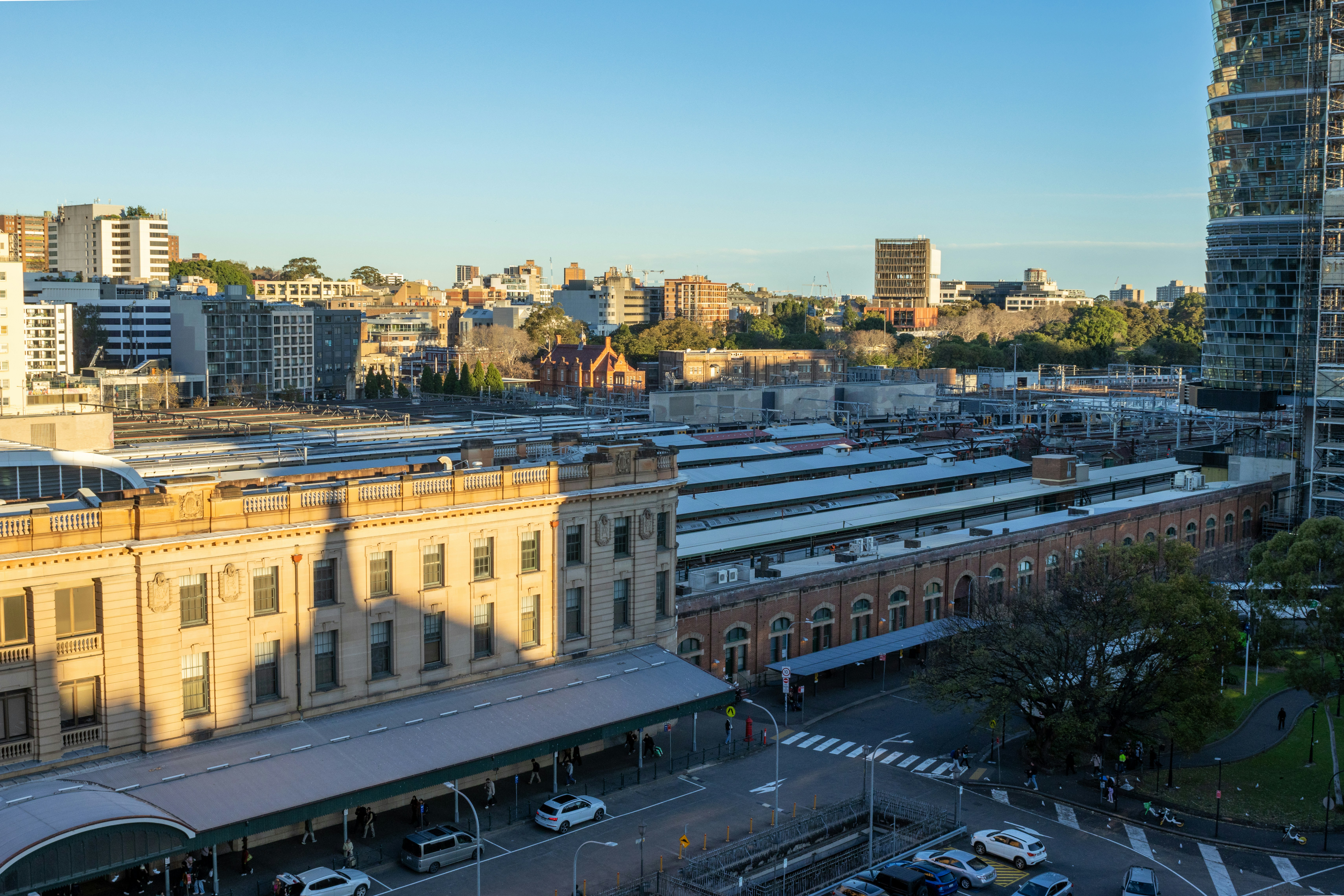 Sunlit City Edge: Historic Rooflines and Modern High-Rloor Shadows