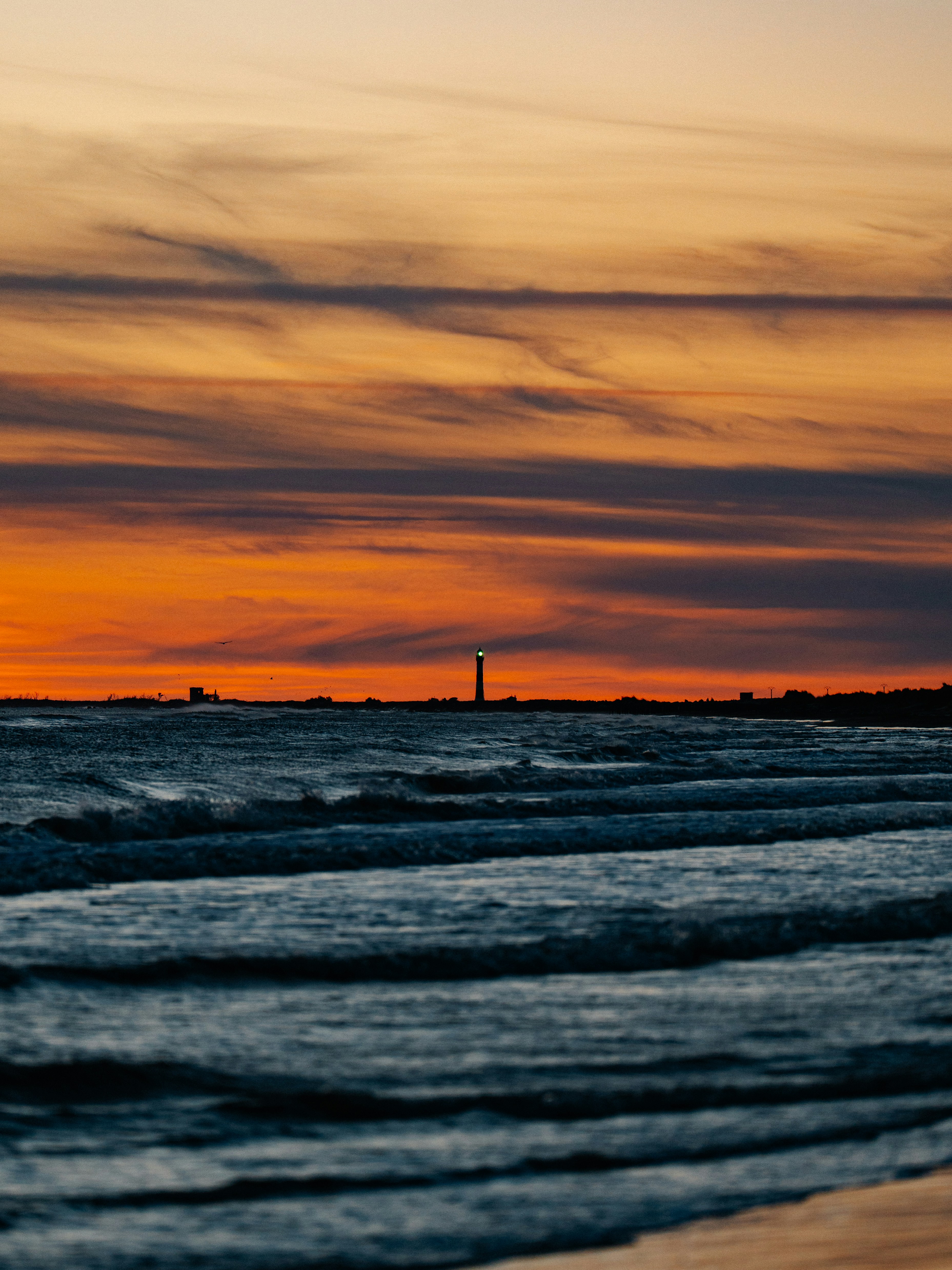 Silhouette of a coastal beacon at sunset